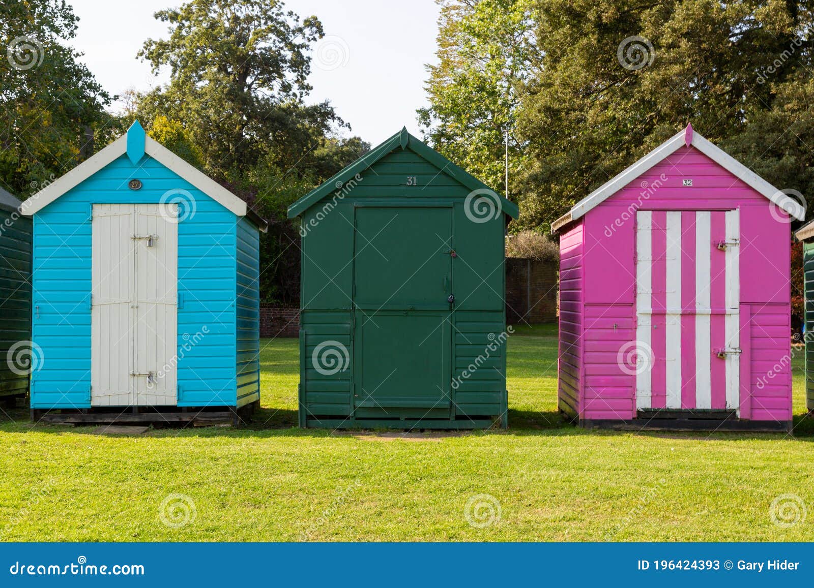 Three Colourful Wooden Beach Huts at the British Seaside Stock Image ...