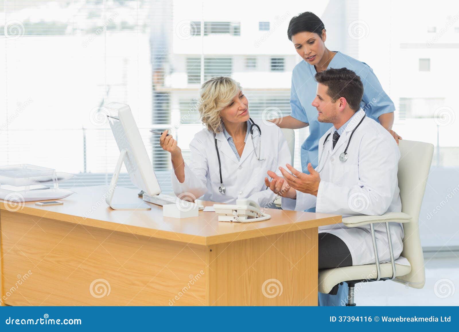 Three Concentrated Doctors Using Computer Together Stock Photo - Image ...