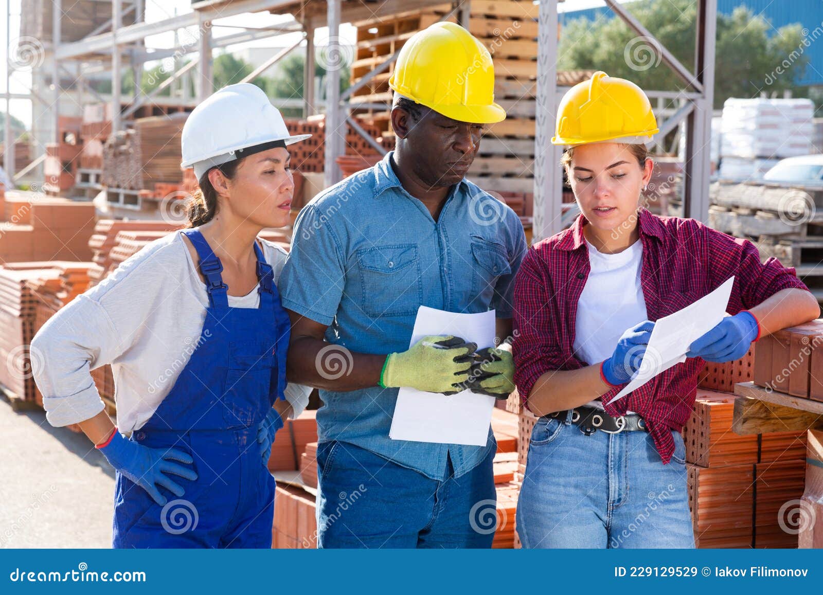 Three Concentrated Workers are Discussing Work Issues at the Warehouse ...