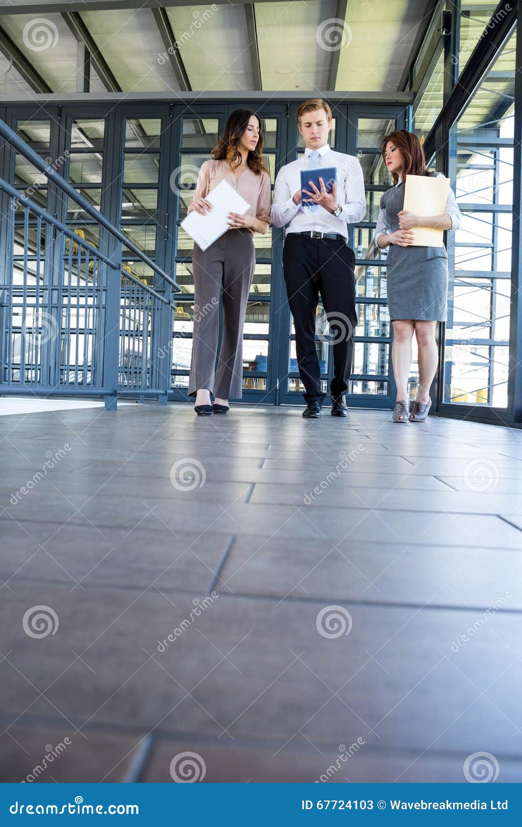 Three Confident Colleagues Discussing in Office Stock Image - Image of ...