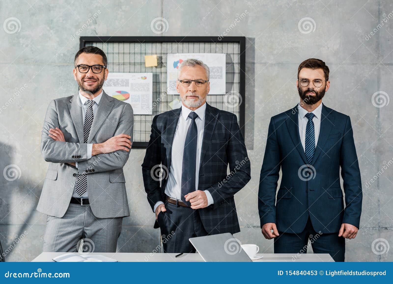Three Confident Professional Businessmen Standing Together and Looking ...