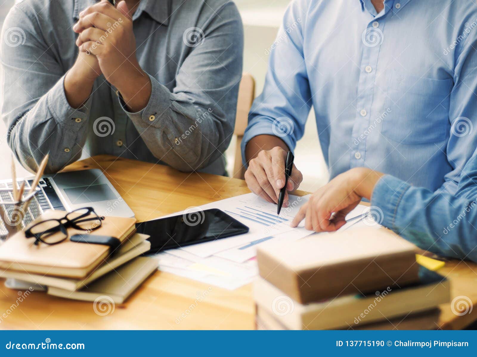 Three Confident Students Reading a Book or Doing Homework Together ...