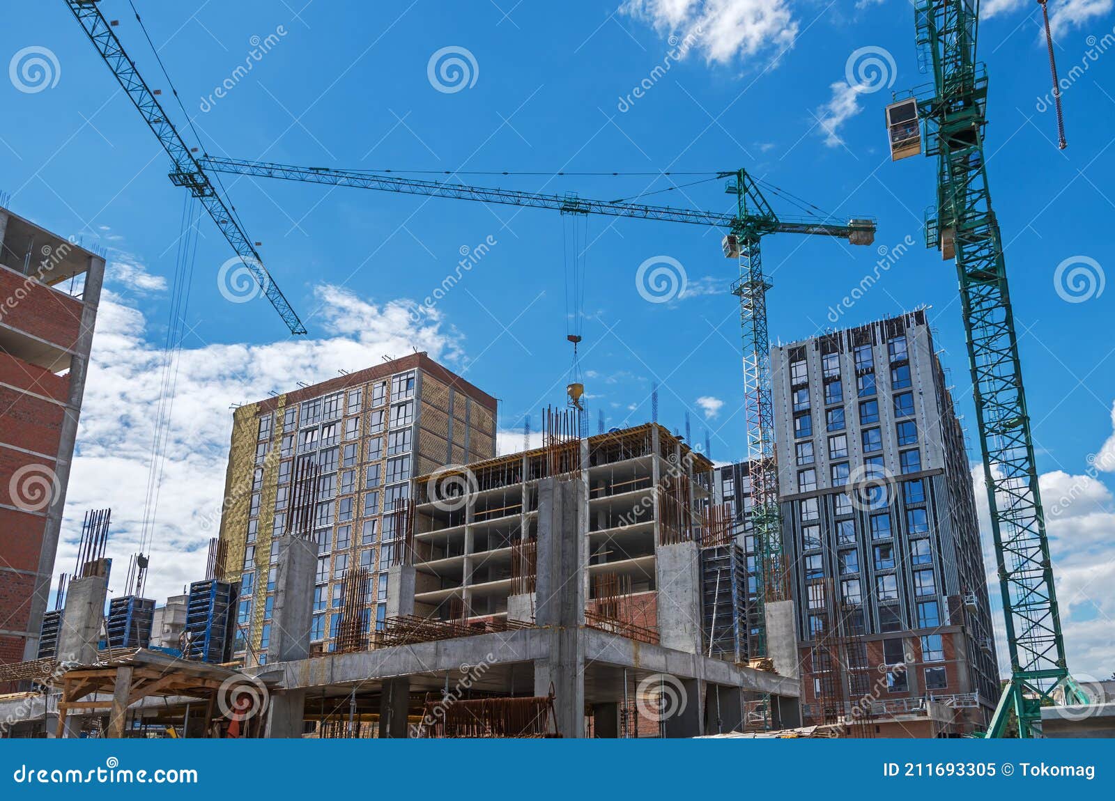 Three construction cranes stock image. Image of buildings - 211693305