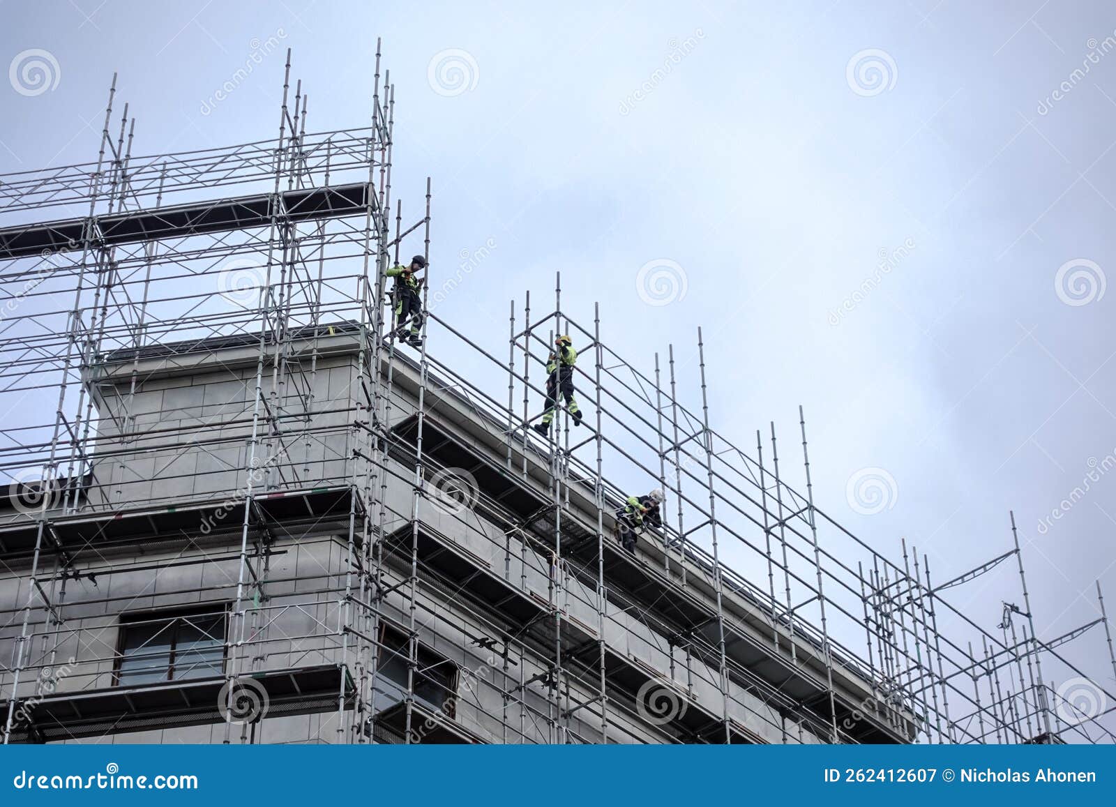 Construction Workers on Scaffolding High Up on Commercial Building ...