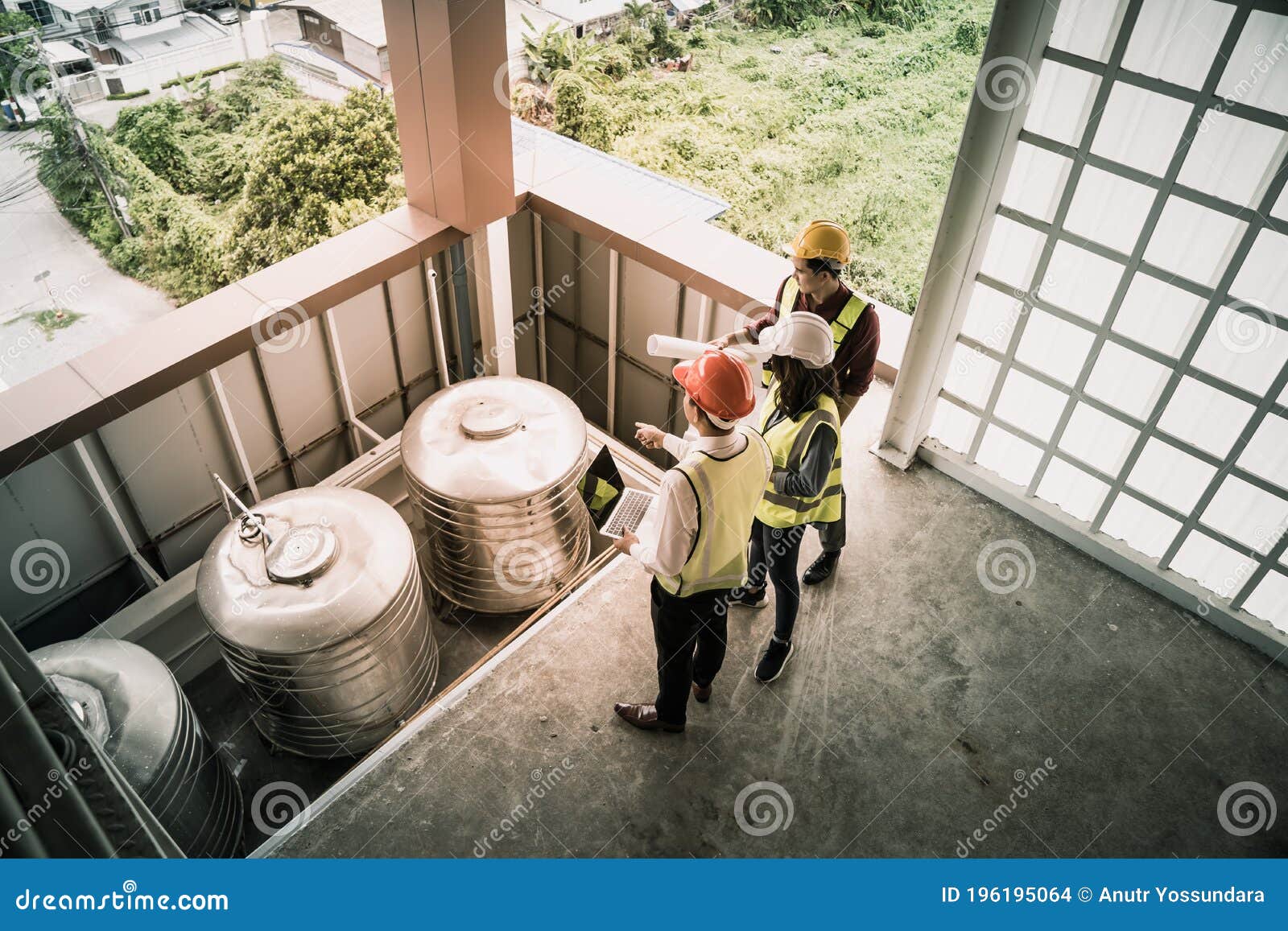 Three Contractor Team Brainstorming On Building Plan At The Far End Of ...