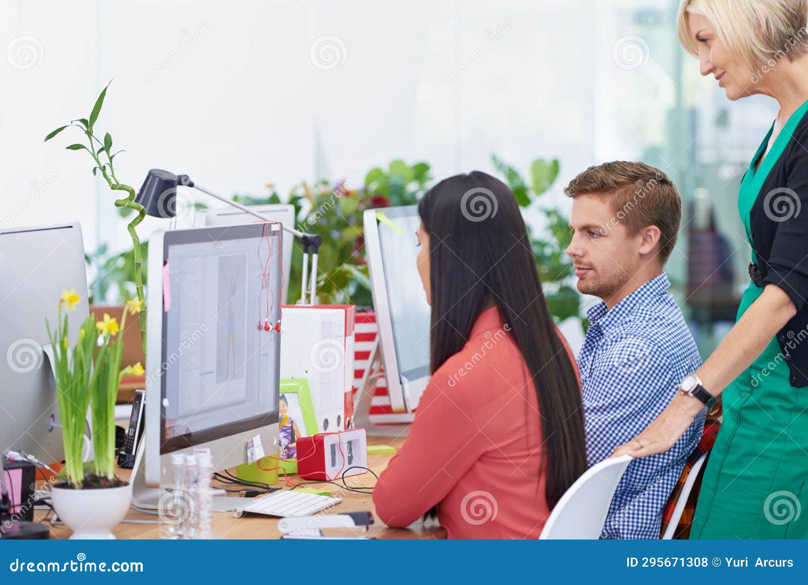Three Coworkers Working Together on a Single Computer. a Group of ...