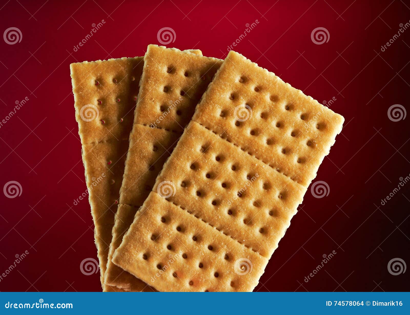 Three crackers on red stock photo. Image of cookies, shape - 74578064