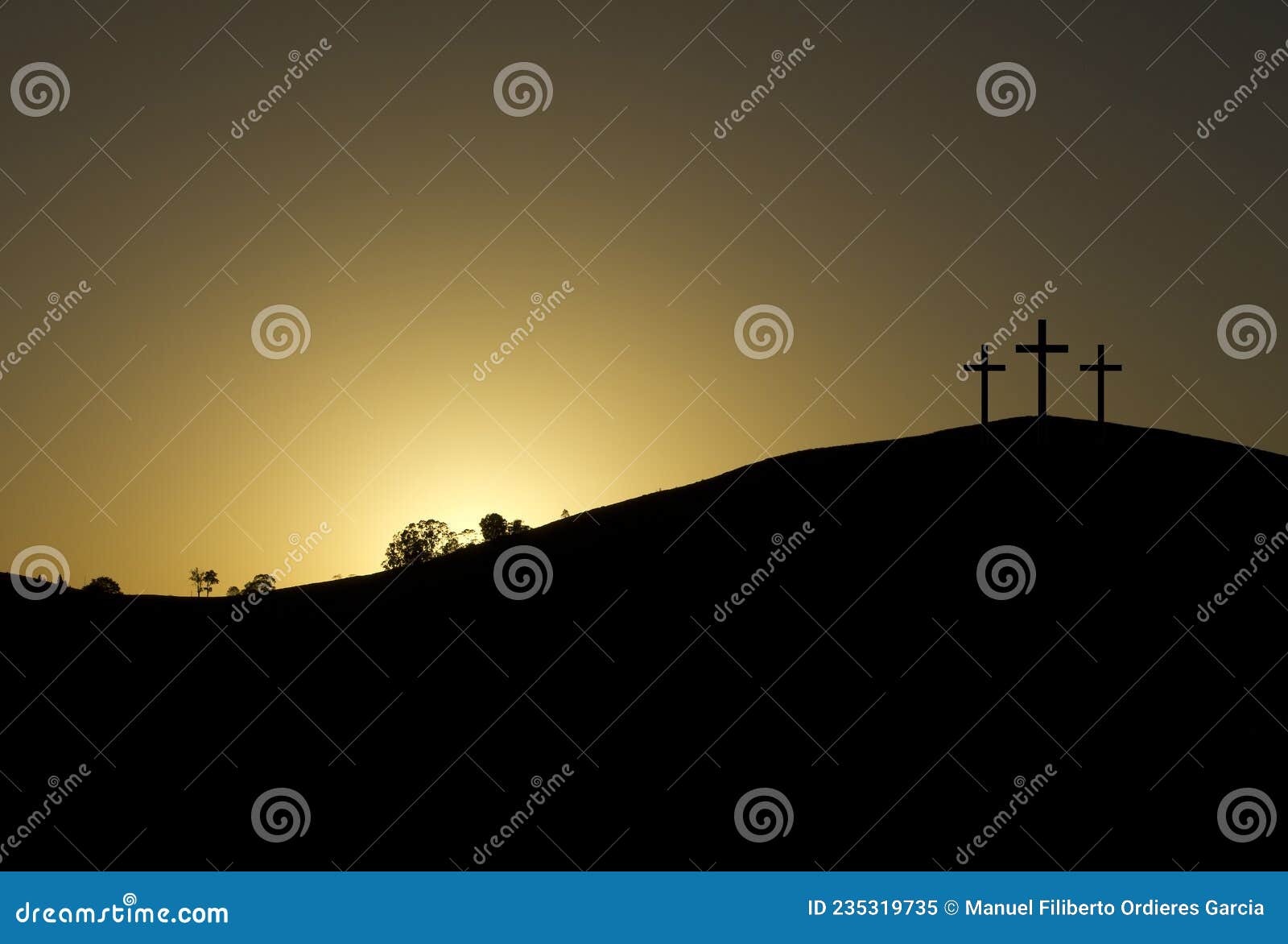 Three Crosses Backlit on Top of a Mountain at Sunrise with a Golden Sky ...