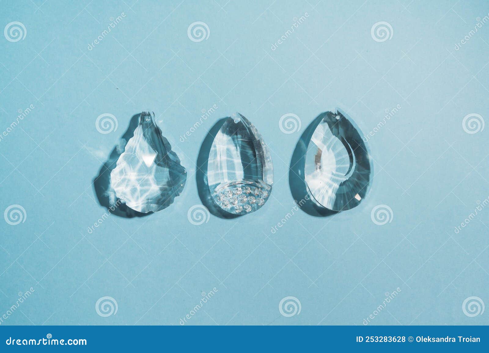 Three Crystals with Light Refraction on Blue Minimal Background Stock ...