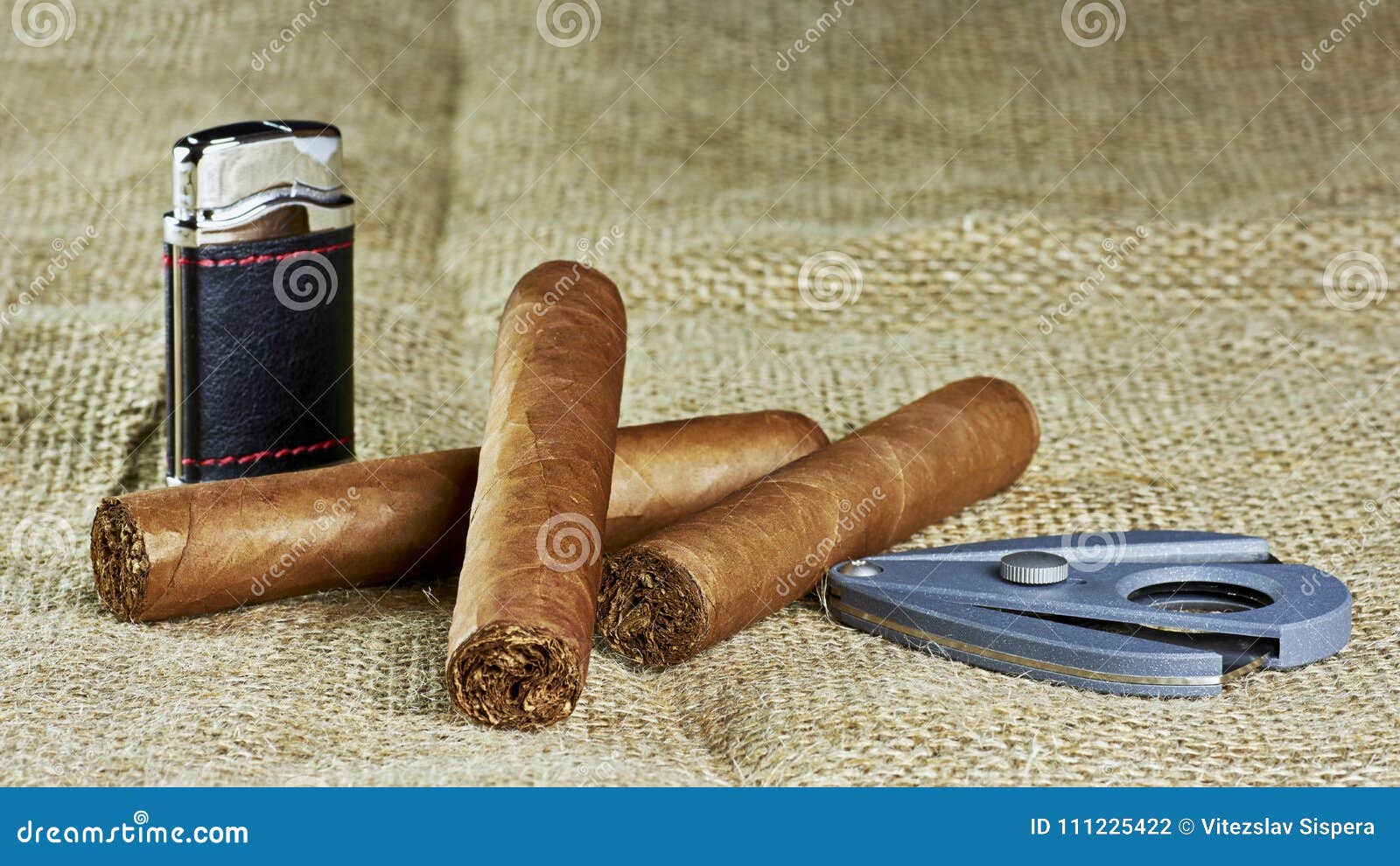 Three Cuban Cigars with a Lighter and a Cutter on a Jute Stock Photo ...