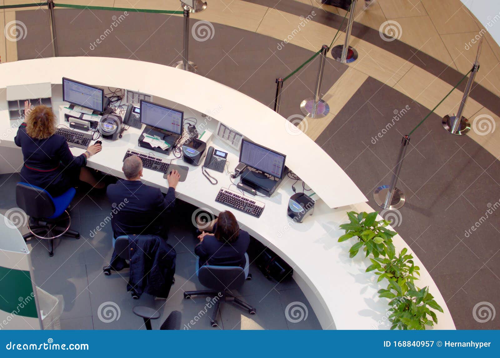Three Customer Service Agents Working at a Help Desk Editorial ...