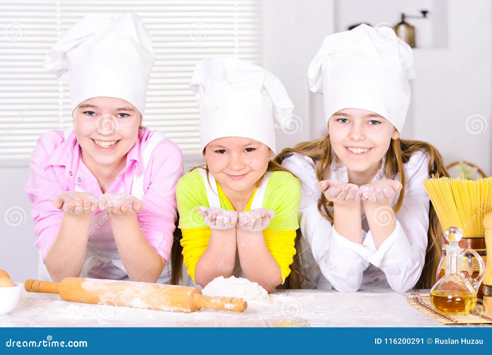 Three cute girls cooking stock image. Image of children - 116200291