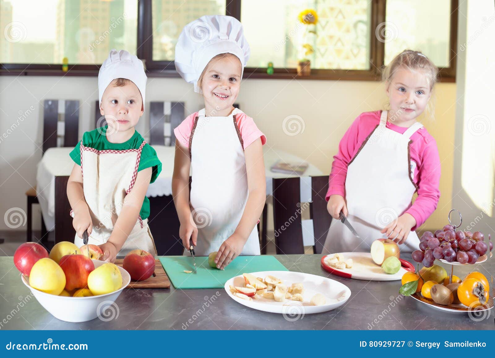 Three Cute Kids are Preparing a Fruit Salad in Kitchen Stock Image ...