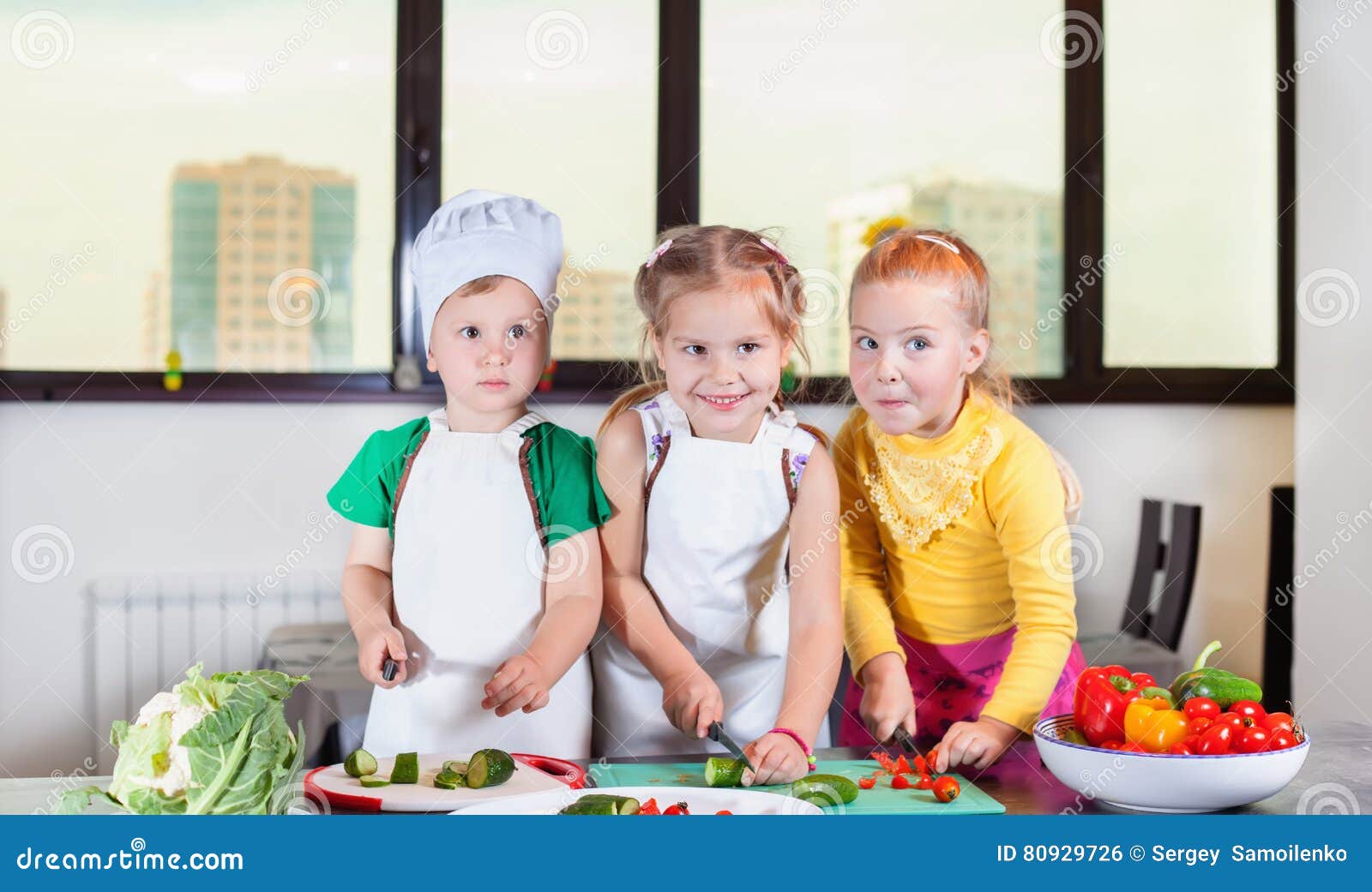 Three Cute Kids are Preparing a Salad in the Kitchen Stock Photo ...