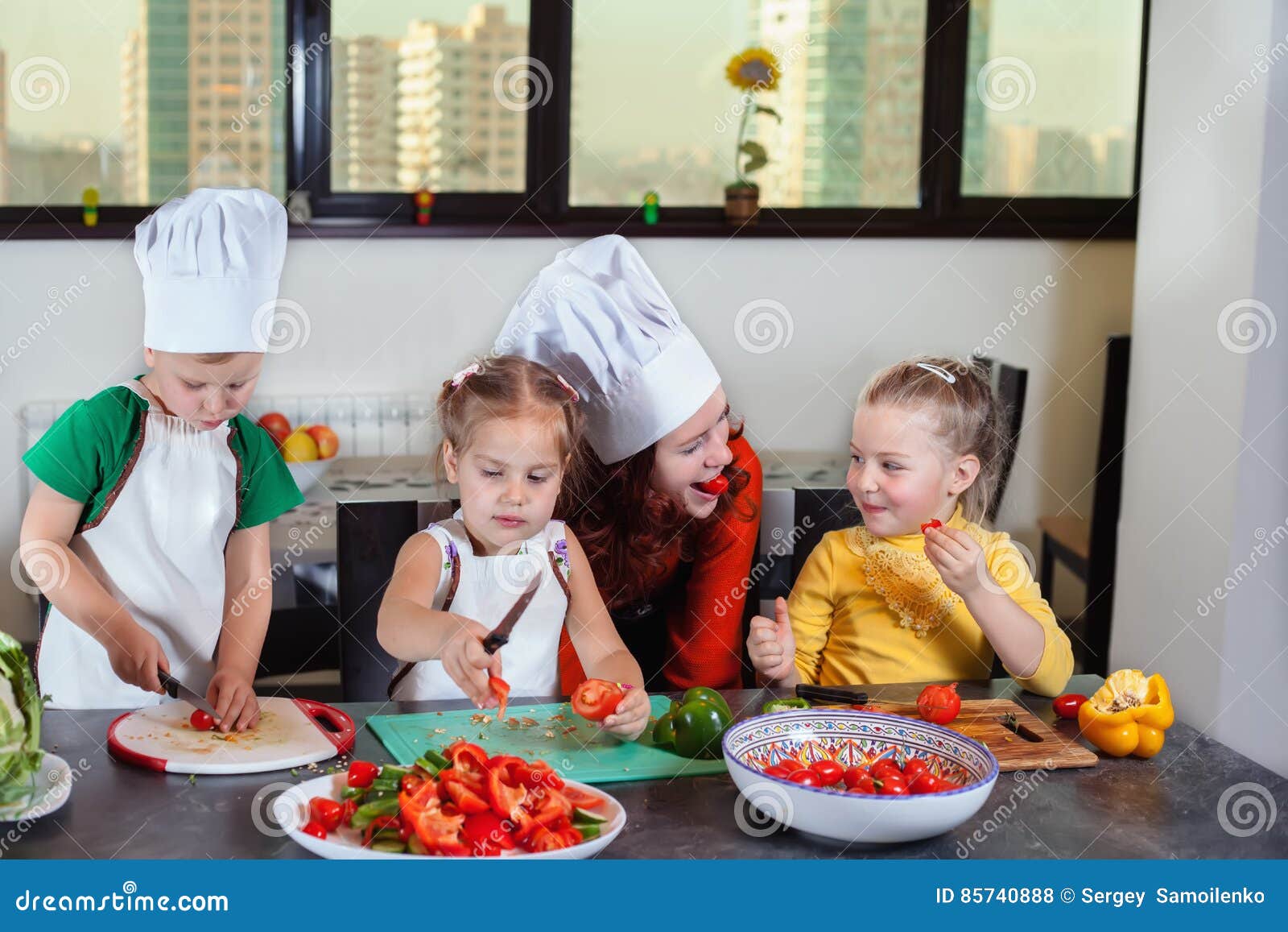 Three Cute Kids are Preparing a Salad in the Kitchen Stock Photo ...