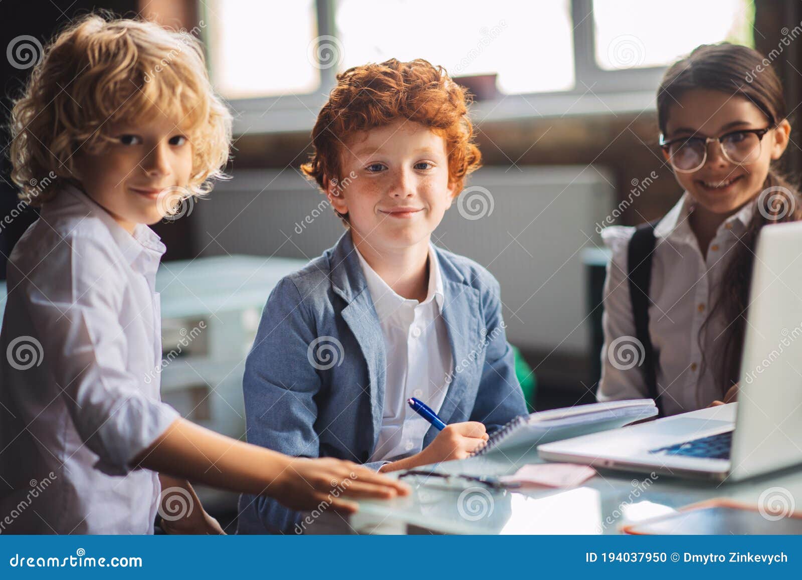 Three Cute Kids Studying in the Classroom and Looking Happy Stock Photo ...