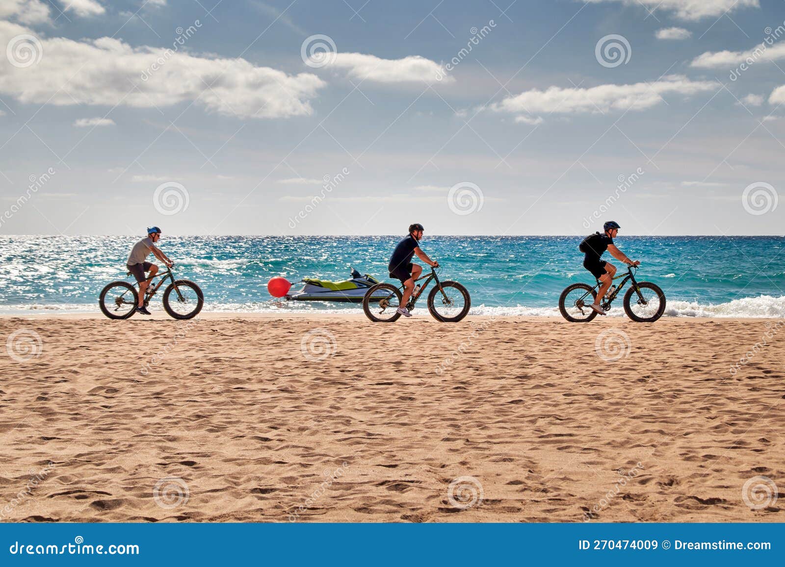 Three Cyclists Biking In A Single File Close To Water In The Westerpark ...