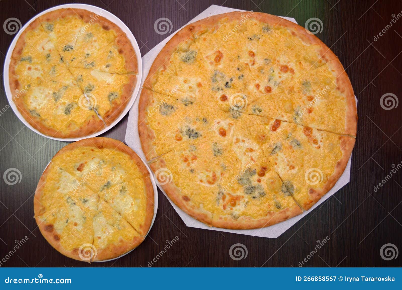 Three Delicious Fresh Four Cheeses Pizzas on Black Table, Three ...