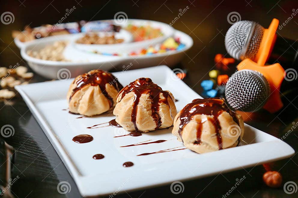 Three Desserts on a Plate with a Microphone in the Background Stock ...