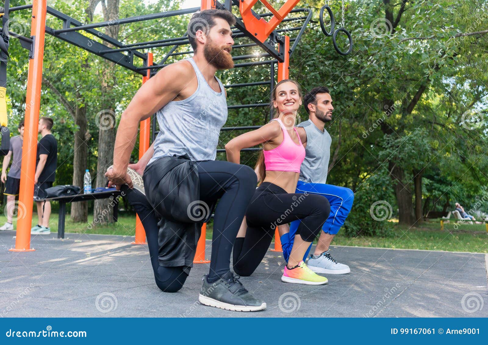Three Determined Friends Doing Stretching Exercises For Legs As Royalty ...
