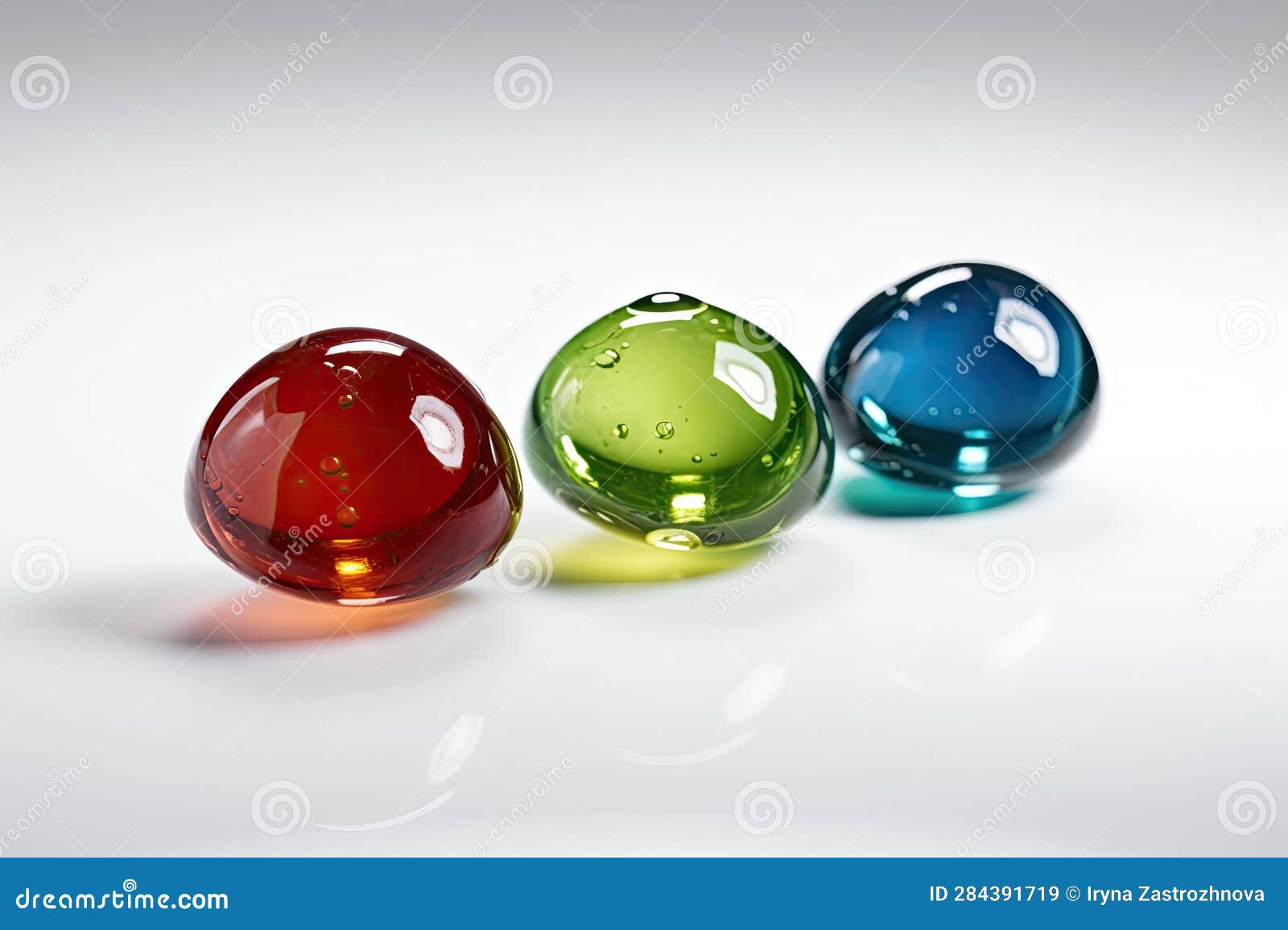 Three Different Drops of Liquid, Red, Blue and Green on a White ...