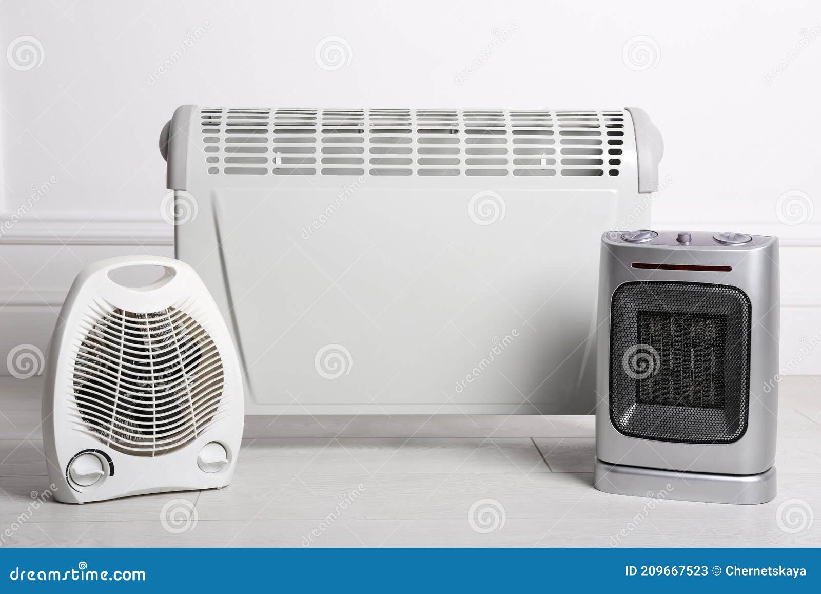 Three Different Electric Heaters on Floor in Room Stock Image - Image ...