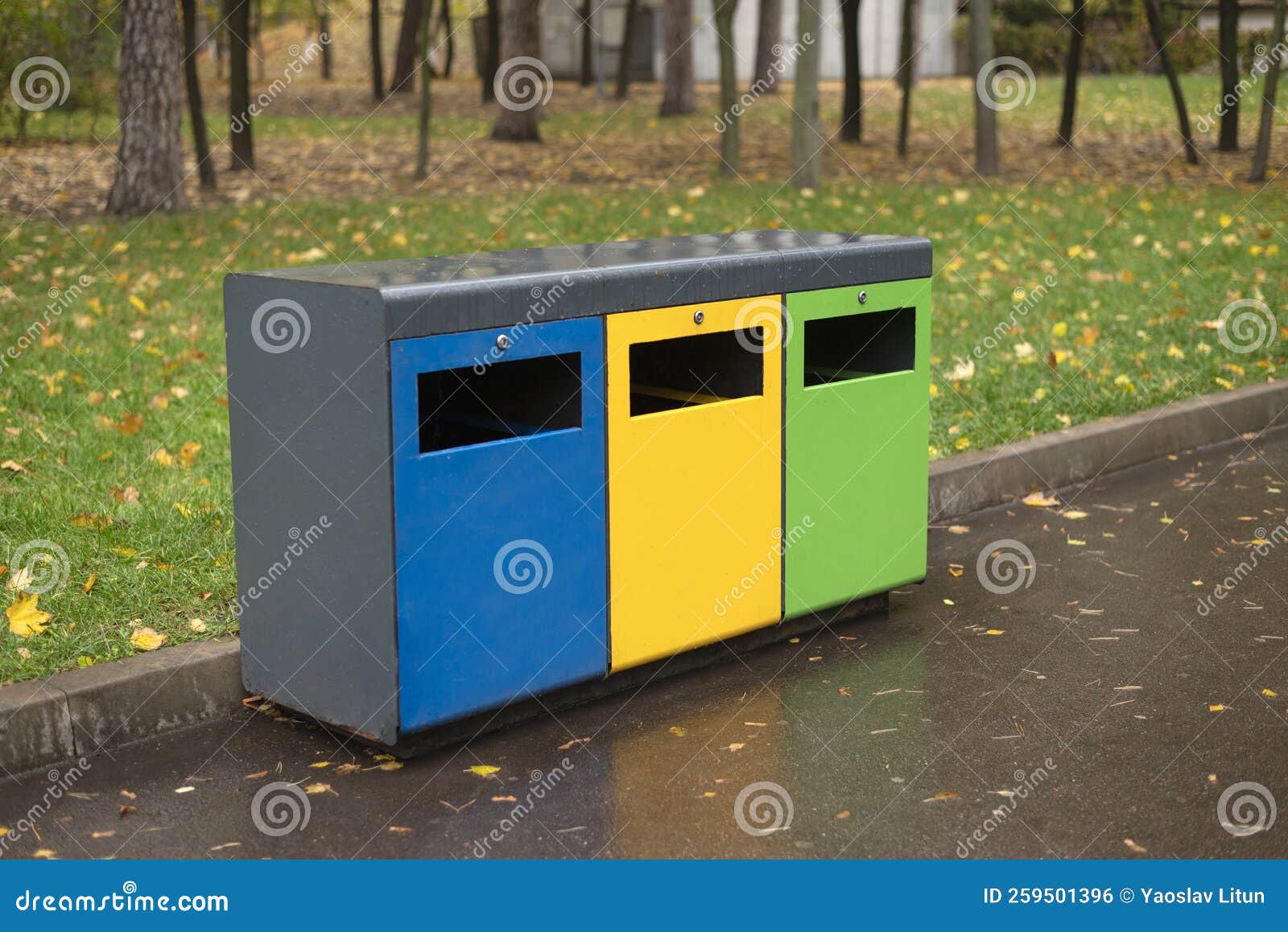 Three Different Garbage Container for Sorting Waste in the Park. Yellow ...