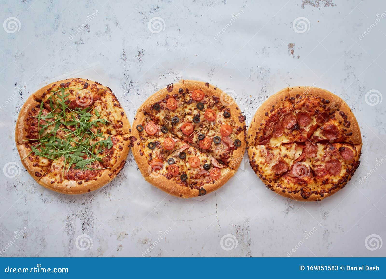 Three Different Kind of Pizzas Placed in a Row on White Rusty Table ...