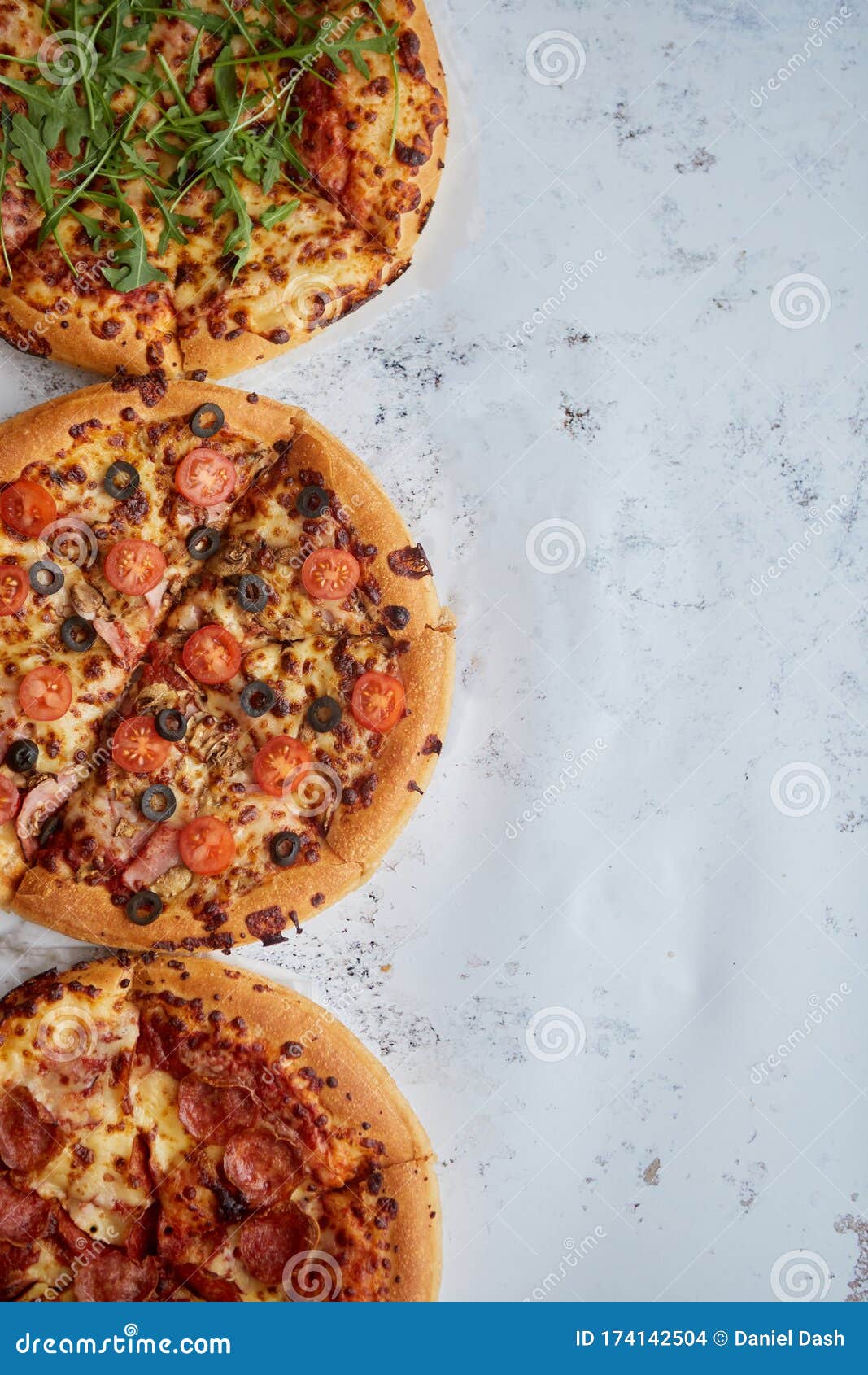 Three Different Kind of Pizzas Placed in a Row on White Rusty Table ...