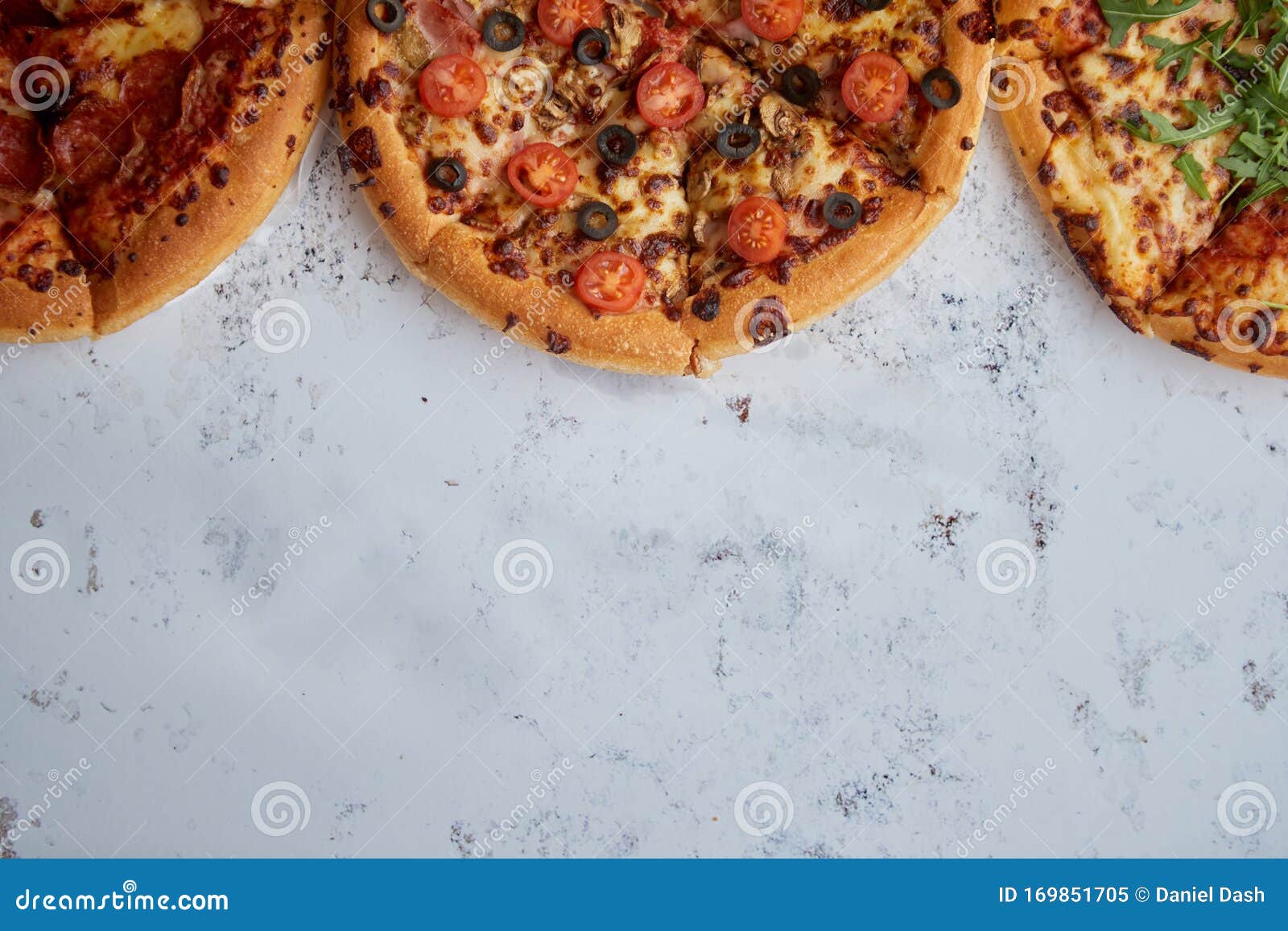Three Different Kind of Pizzas Placed in a Row on White Rusty Table ...
