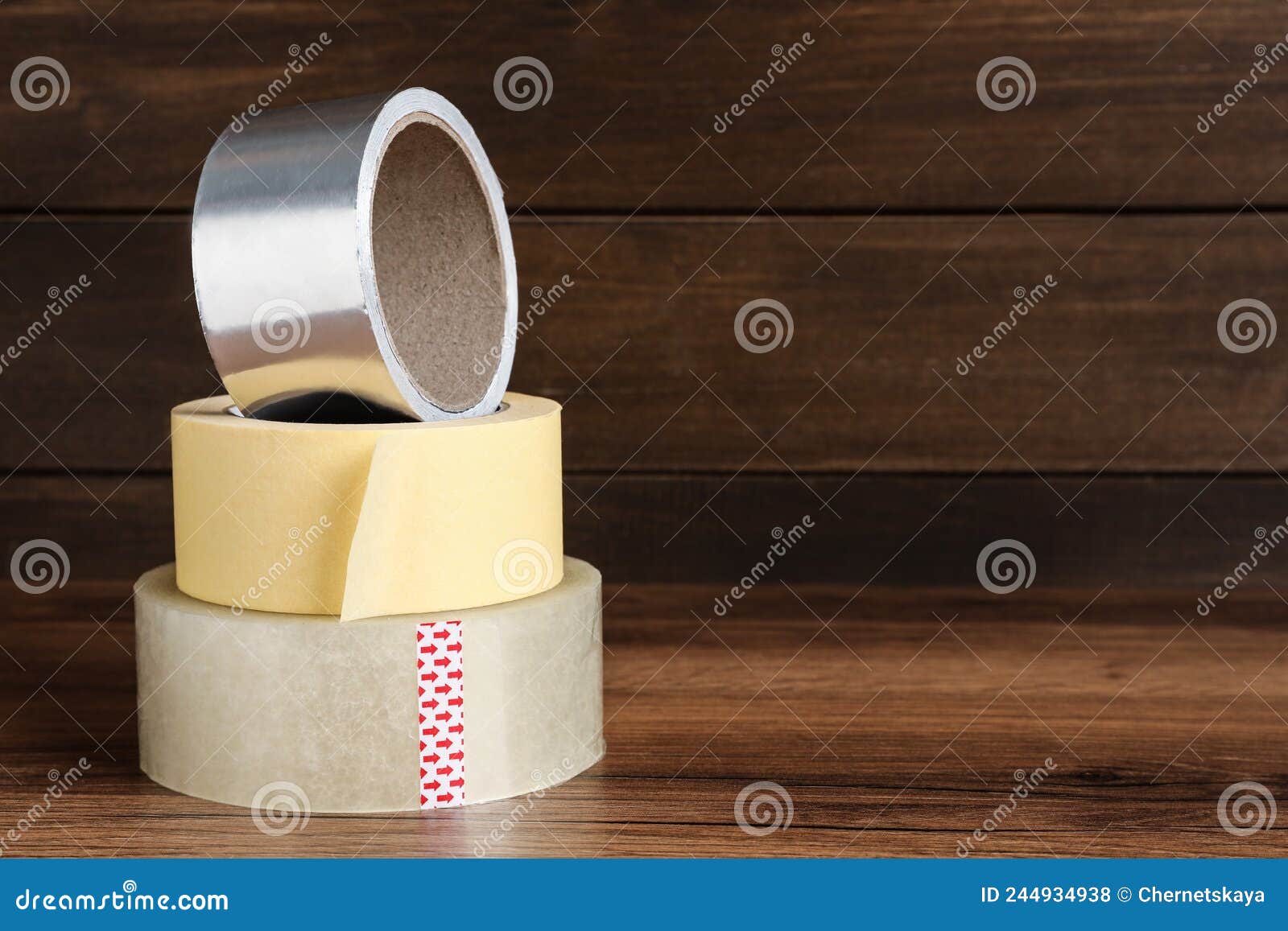 Three Different Rolls of Adhesive Tape on Wooden Table. Space for Text ...