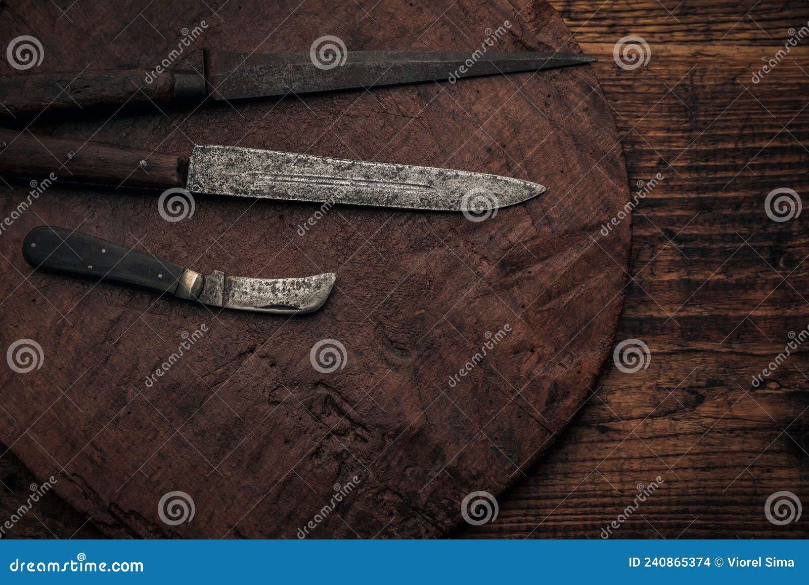 Three Different Rusty Vintage Knives on a Round Old Wood Cutting Board ...