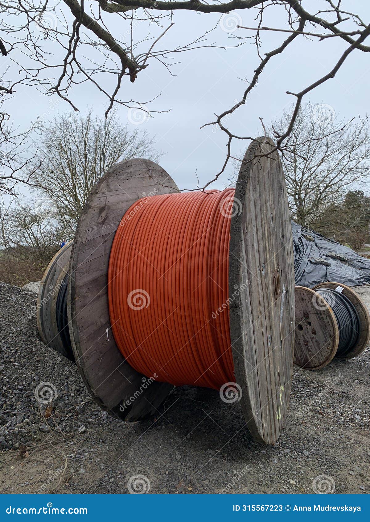 Three Different Sized Wooden Reels with a Cable on a Construction Site ...