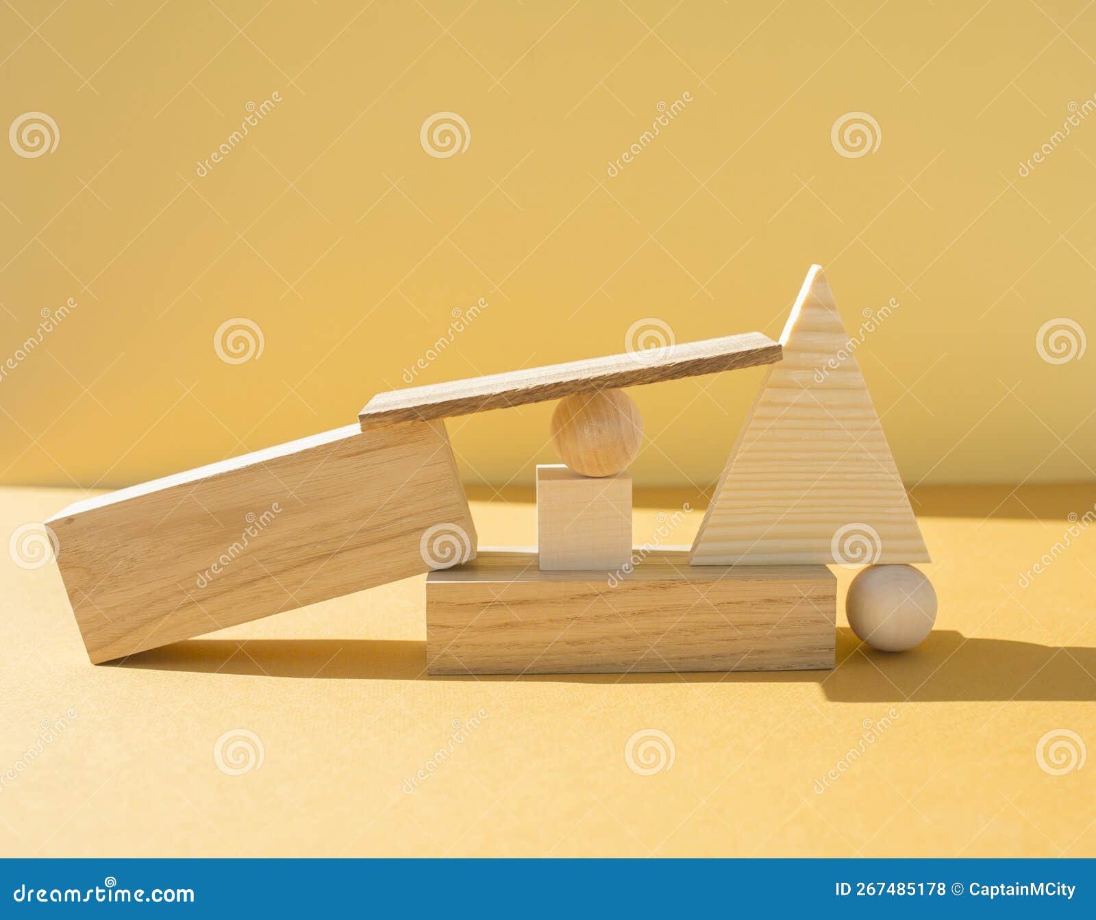 Three-dimensional Wooden Objects on Yellow Background. Balance and ...