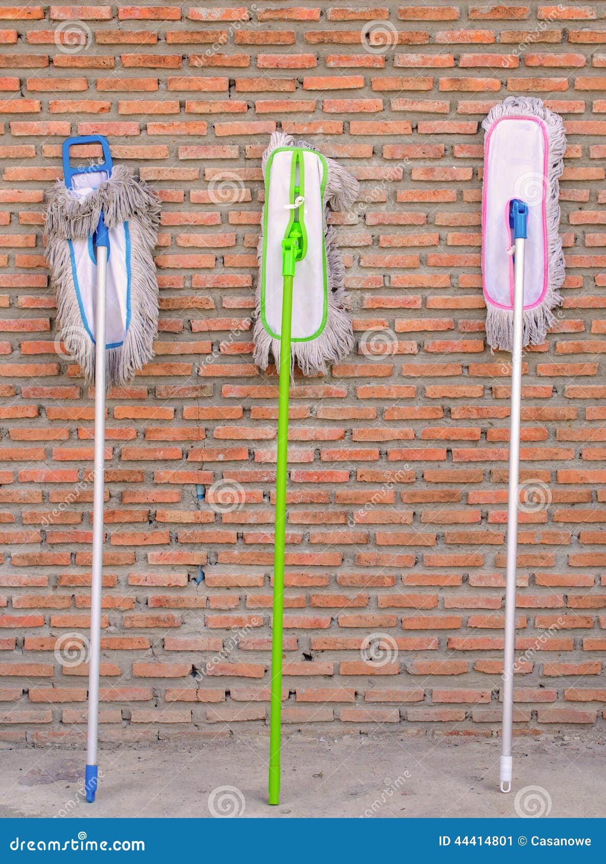 Three Dirty Mop Against on Brick Wall Stock Image - Image of wooden ...