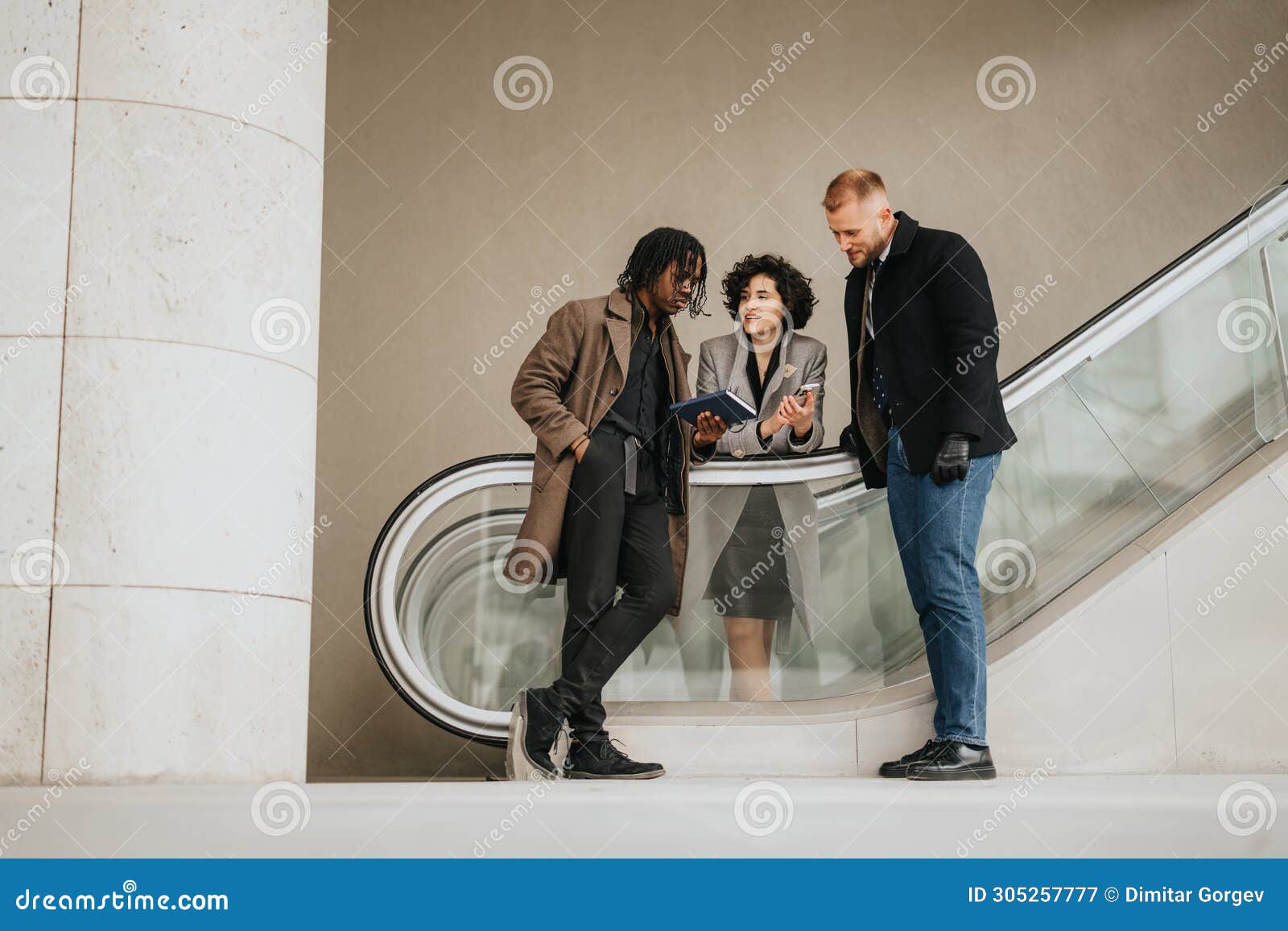 Three Diverse People Engaging in a Serious Discussion while Standing on ...