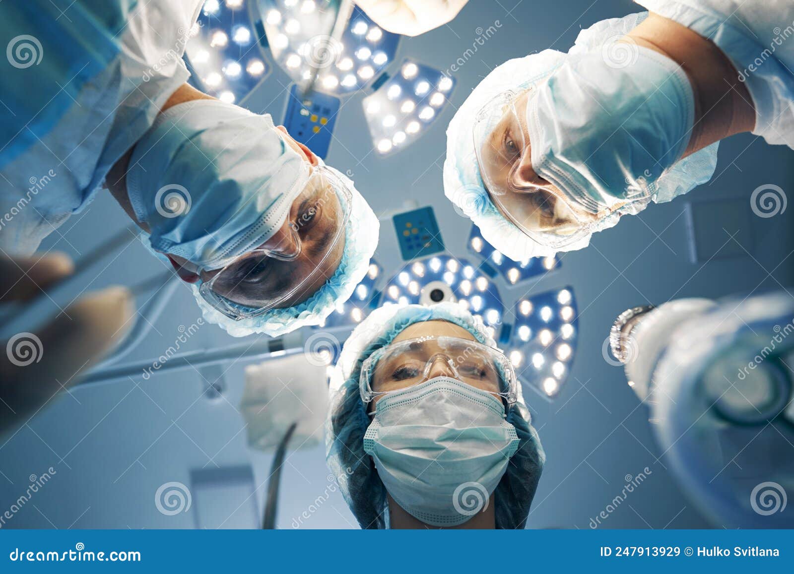 Three Doctors Bending Over Patient during Laparoscopic Operation Stock ...