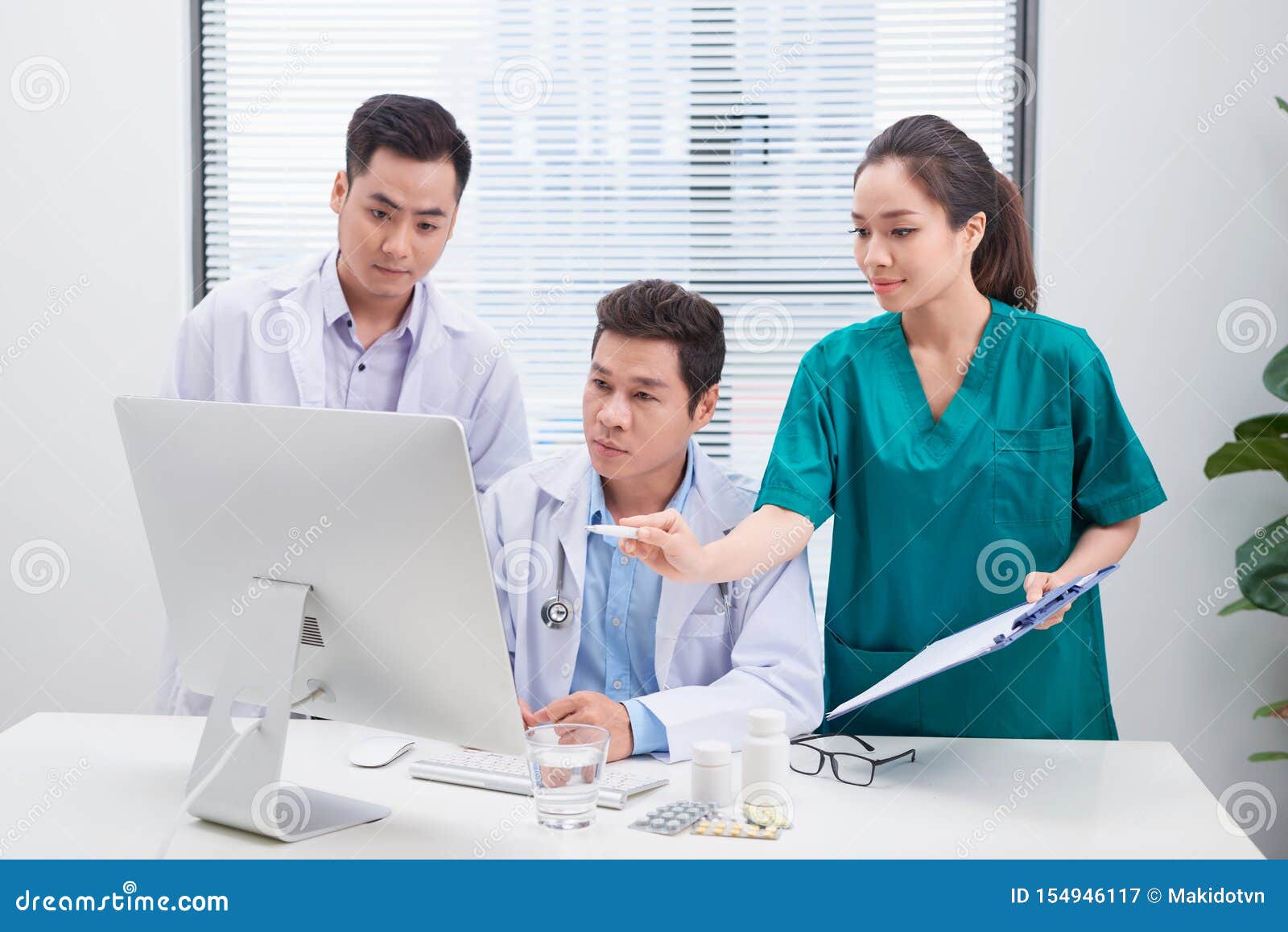 Three Doctors Discussing Patient Files on Office Stock Image - Image of ...