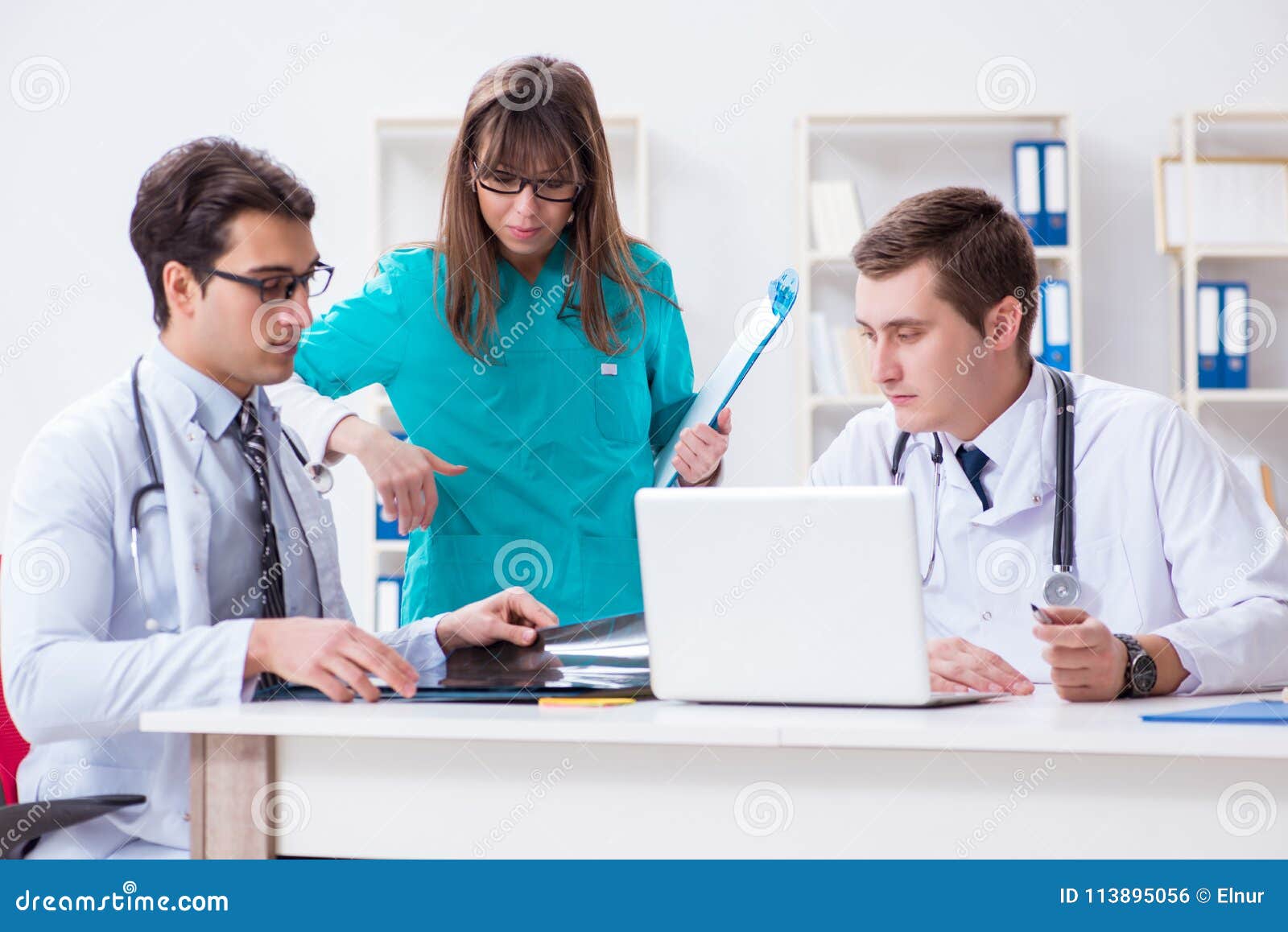 The Three Doctors Discussing Scan Results of X-ray Image Stock Photo ...