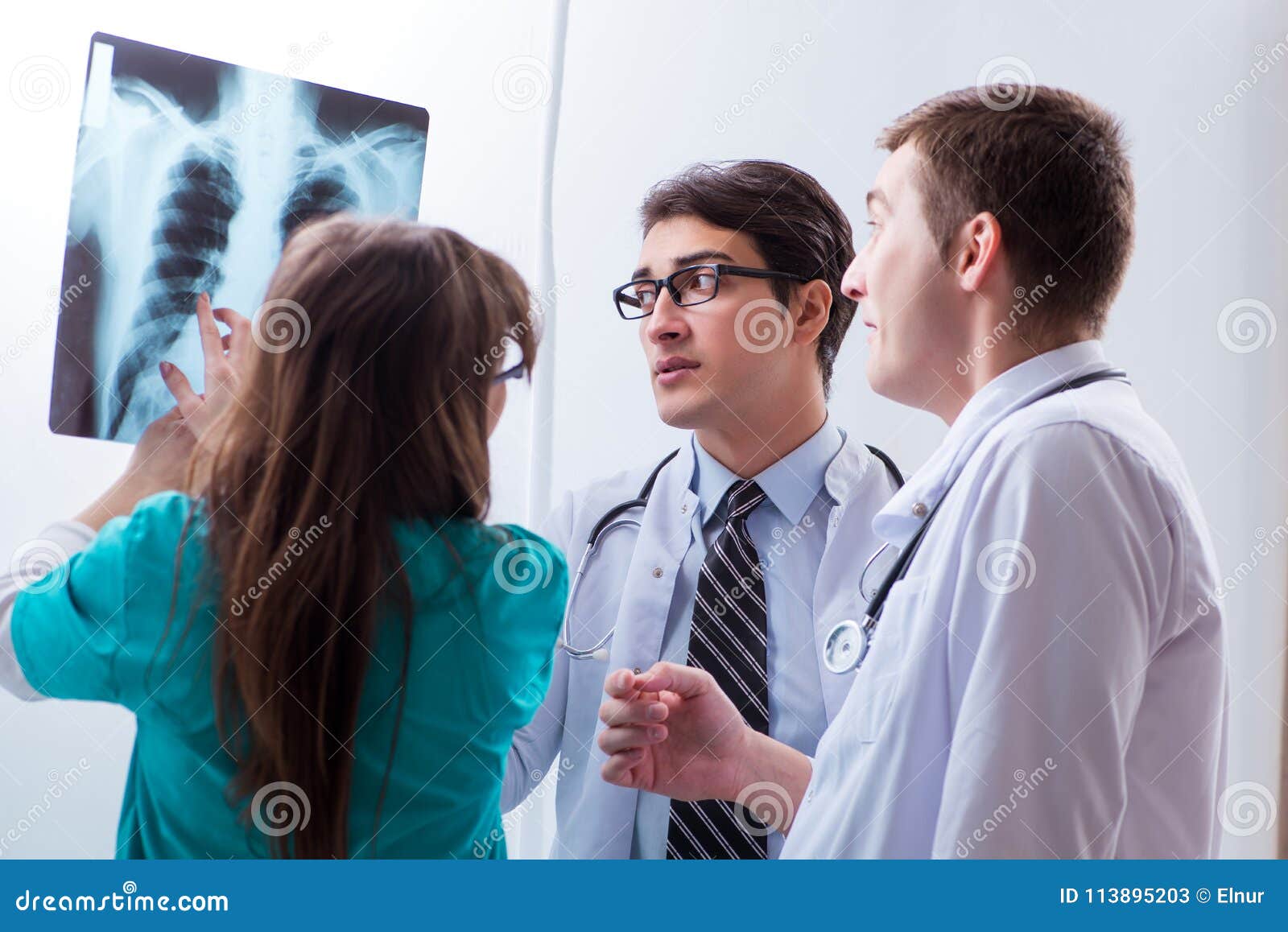 The Three Doctors Discussing Scan Results of X-ray Image Stock Image ...