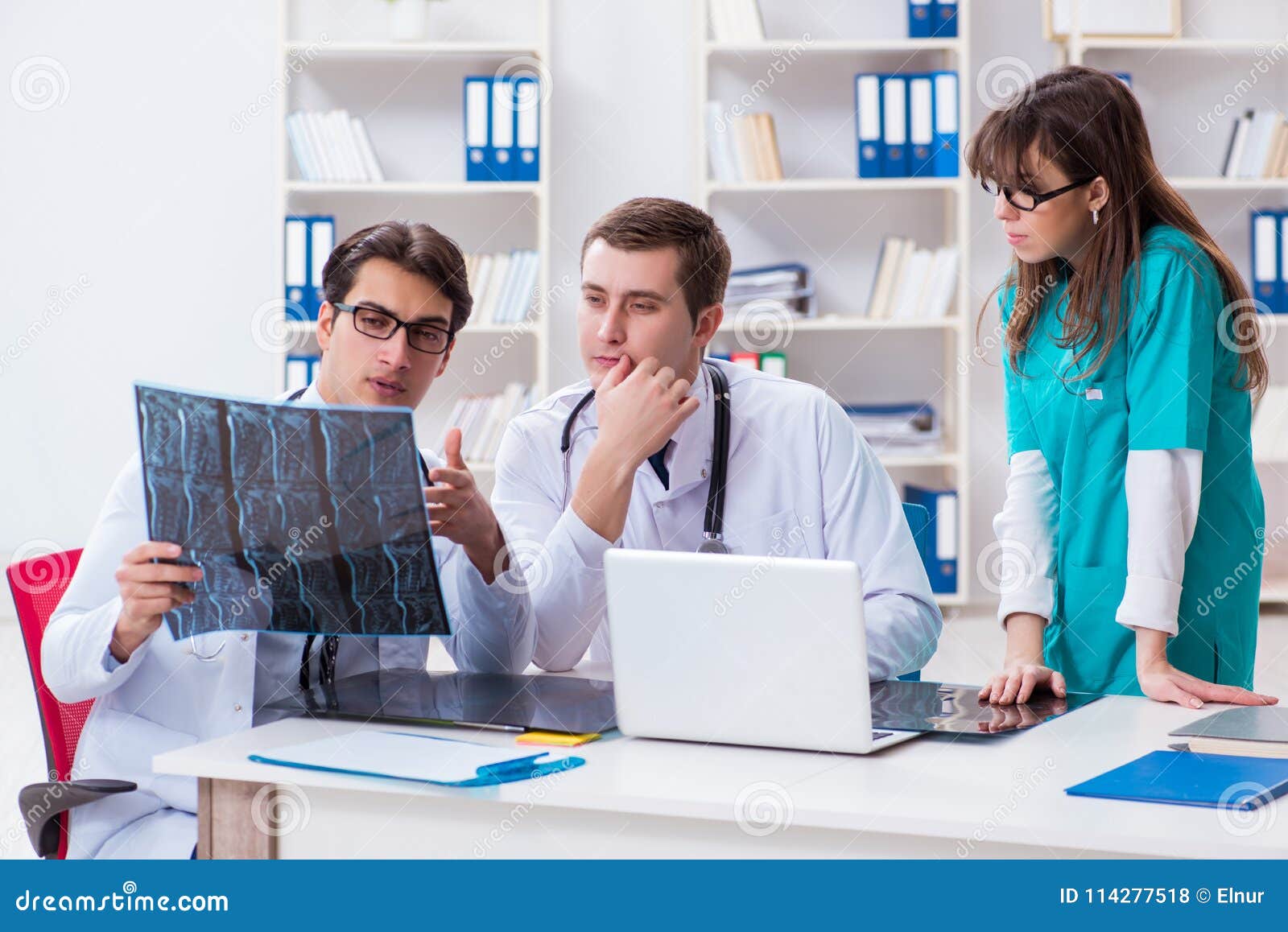 The Three Doctors Discussing Scan Results of X-ray Image Stock Photo ...