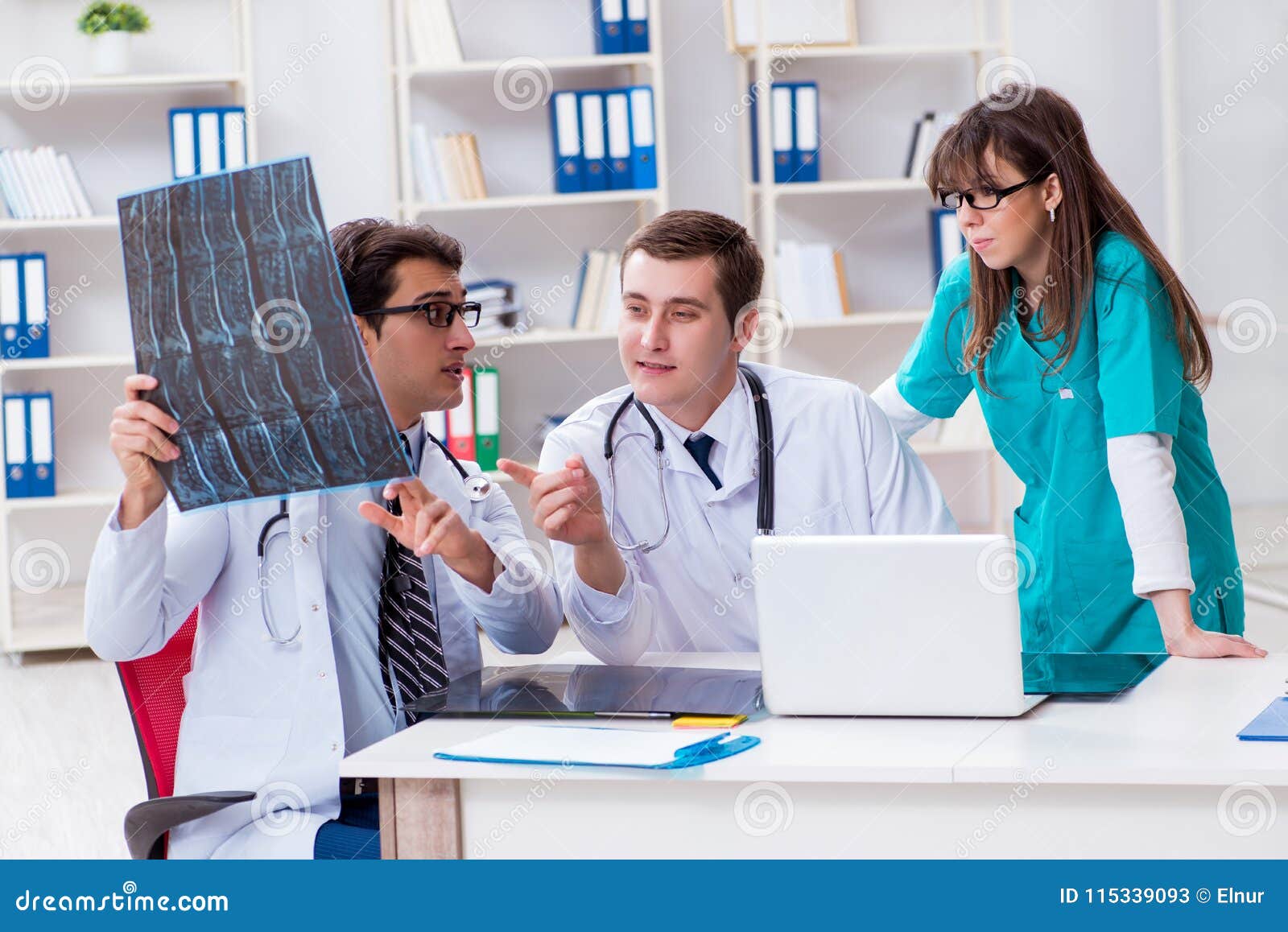 The Three Doctors Discussing Scan Results of X-ray Image Stock Image ...