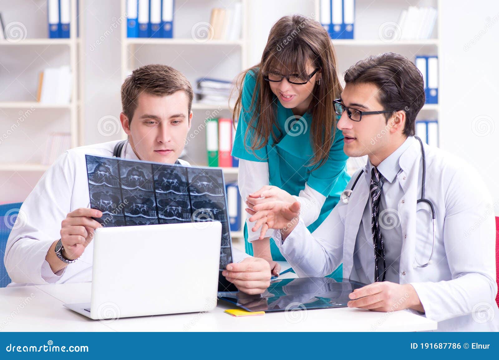 Three Doctors Discussing Scan Results of X-ray Image Stock Photo ...