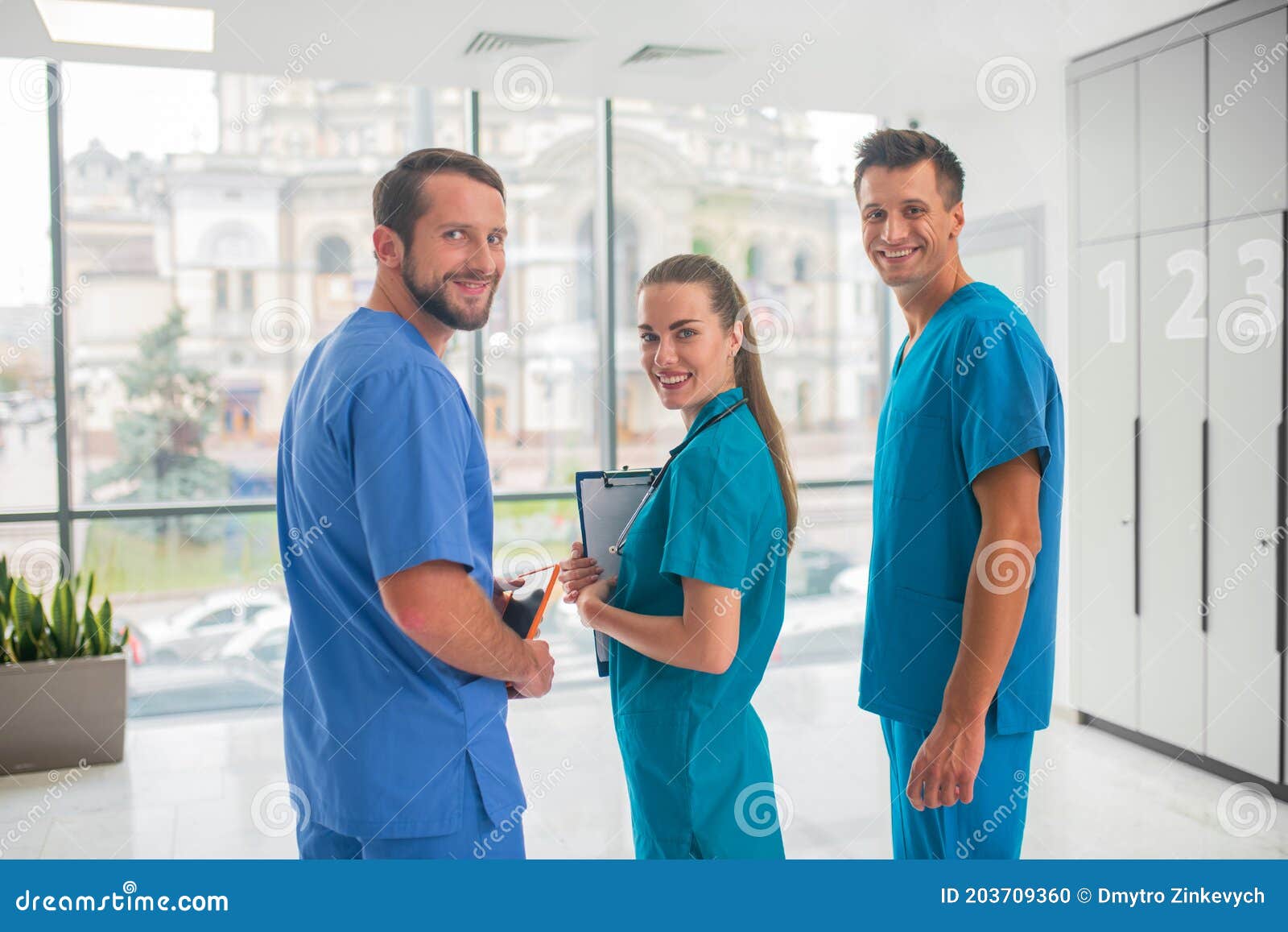 Three Doctors Having a Working Day in Clinic and Looking Confident ...
