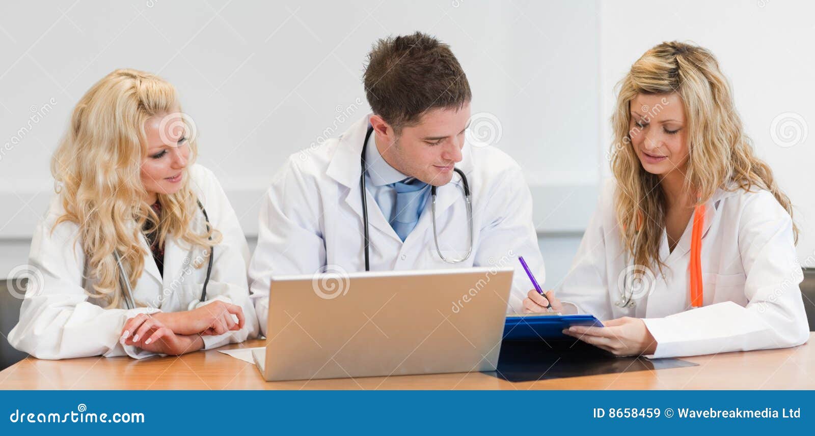 Three doctors at a meeting stock image. Image of health - 8658459