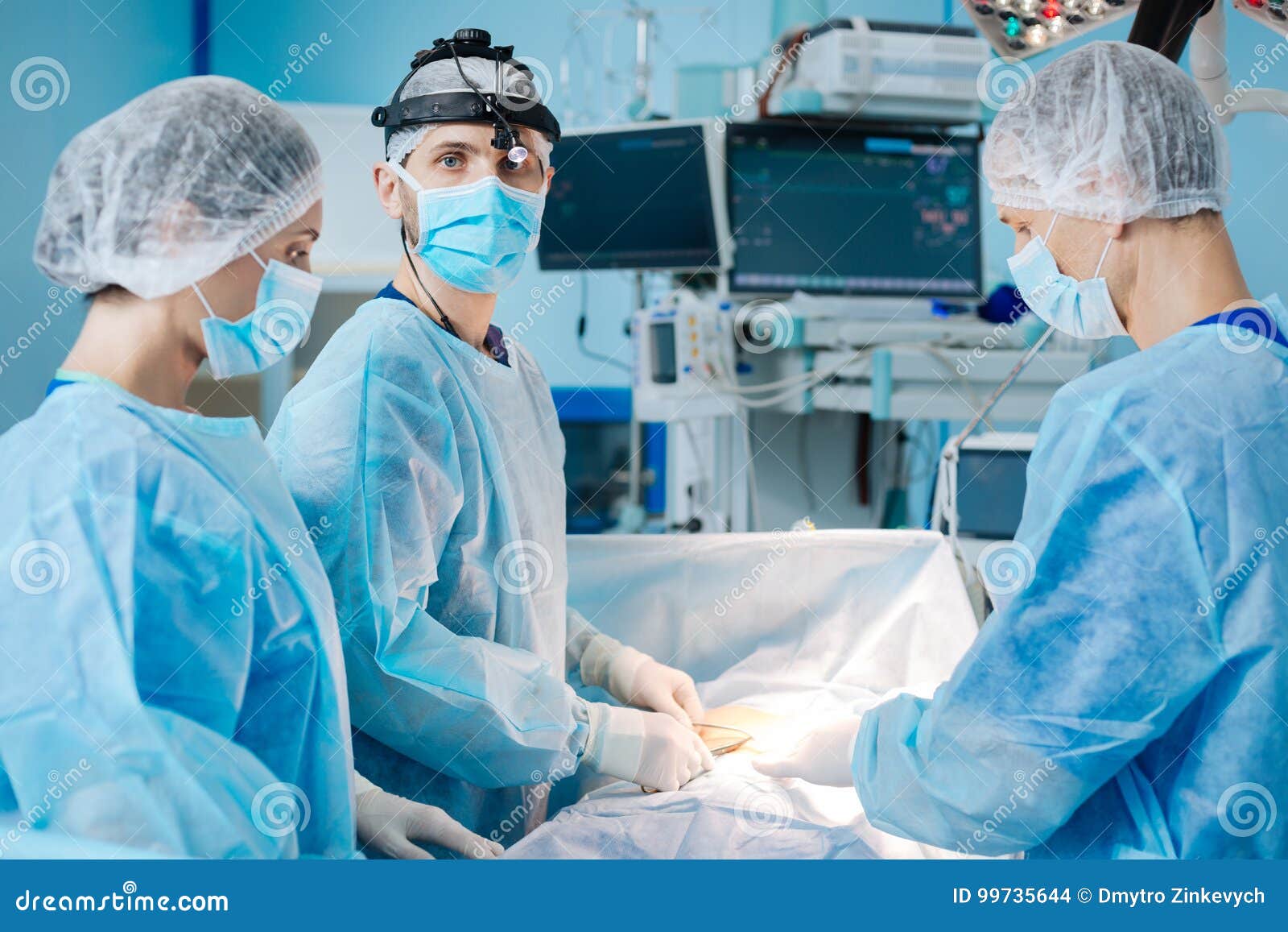 Three Doctors Standing Around Their Patient Stock Photo - Image of ...