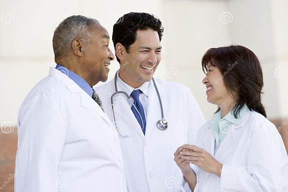 Three Doctors Standing Outside a Hospital Stock Photo - Image of ...