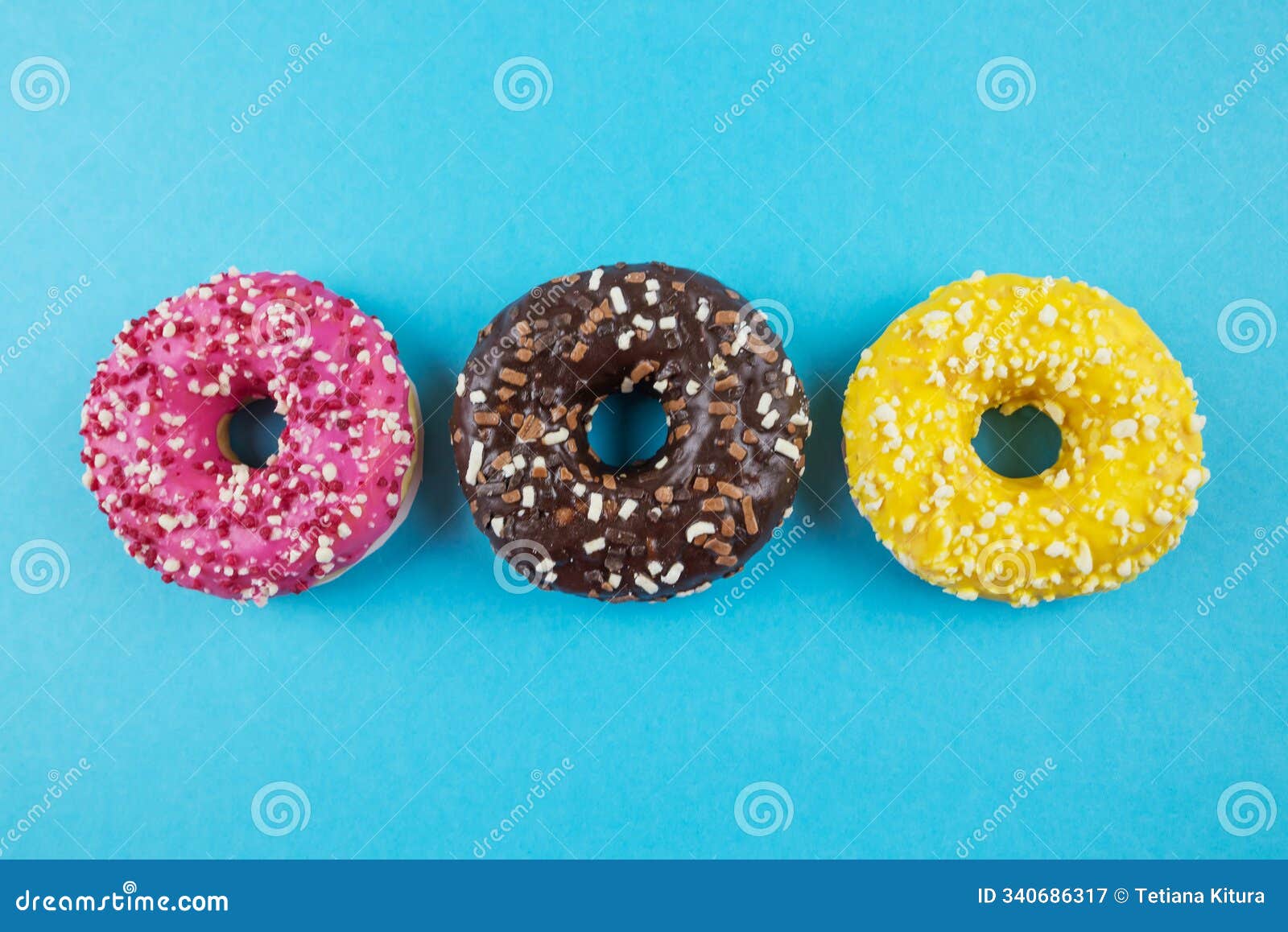 Three Donuts with Different Glazes on a Blue Stock Image - Image of ...