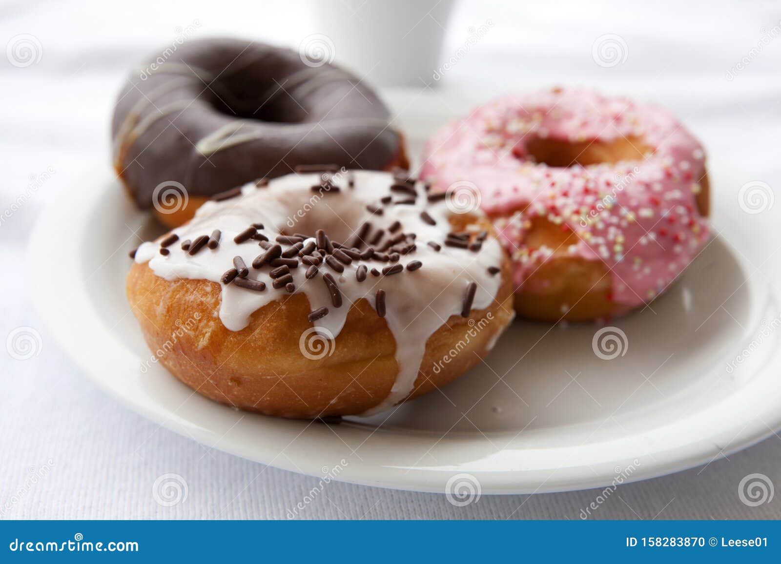 Three Donuts on a Plate stock photo. Image of sprinkles - 158283870