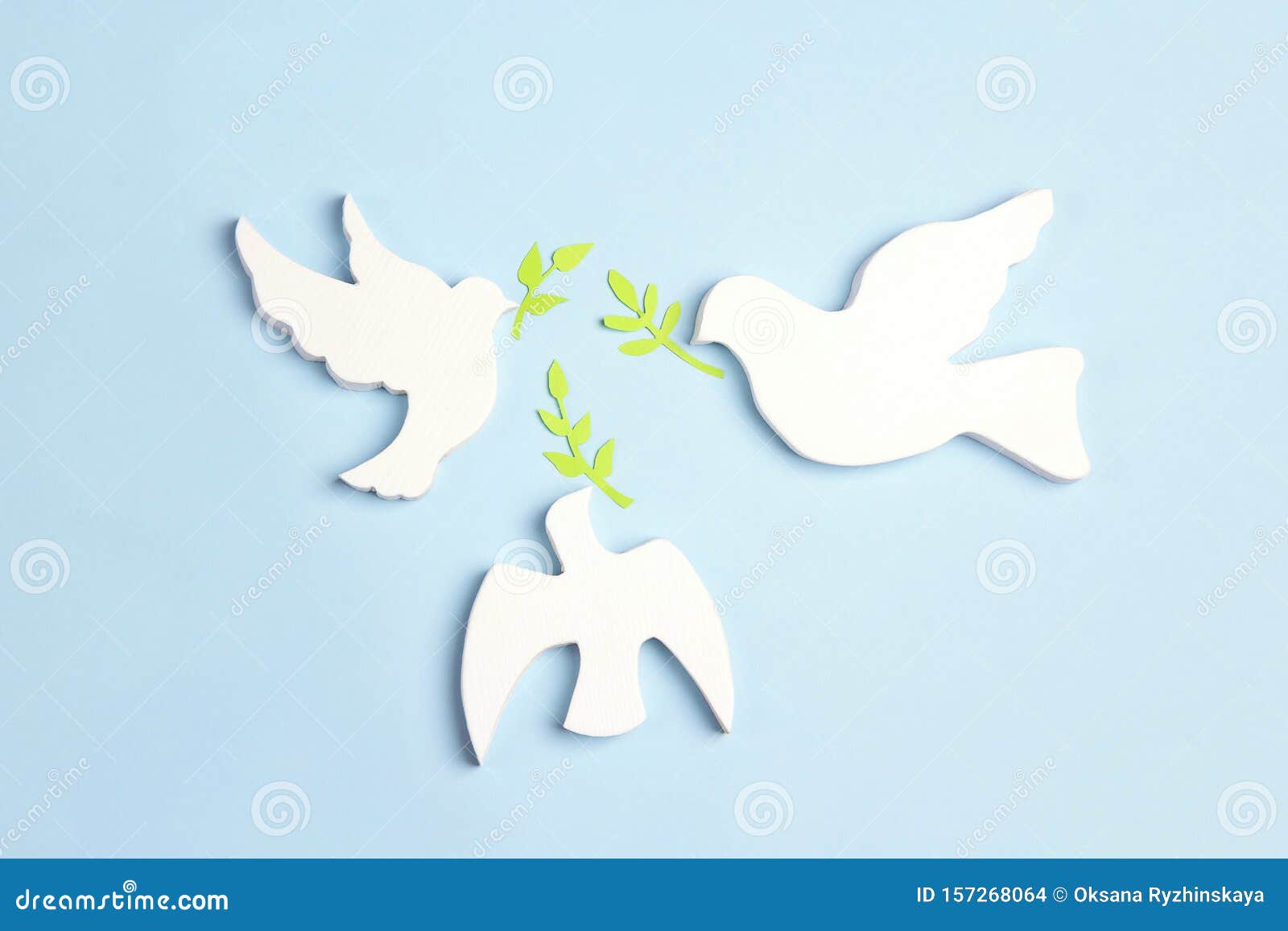 Three Doves of Peace with Olive Branches on a Blue Background Stock ...